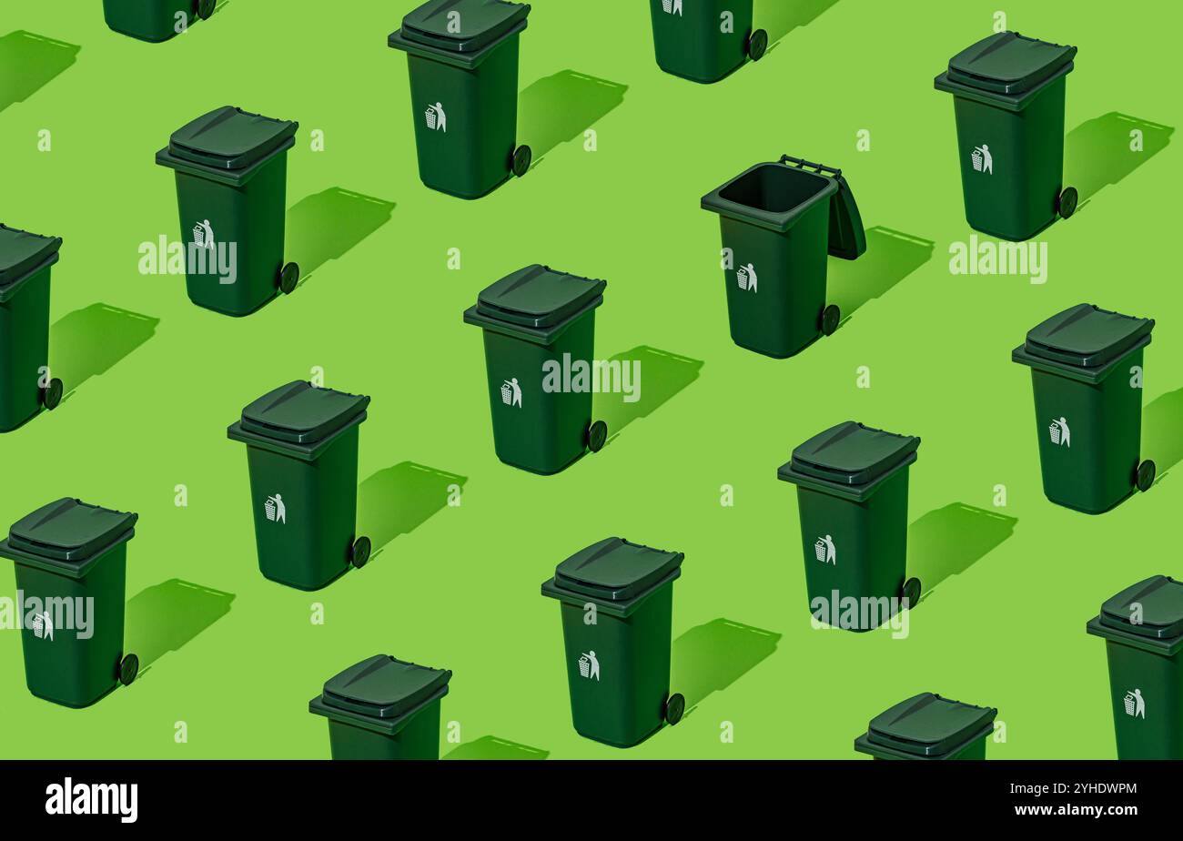 Creative eco pattern made of trash recycle bin on green background ...