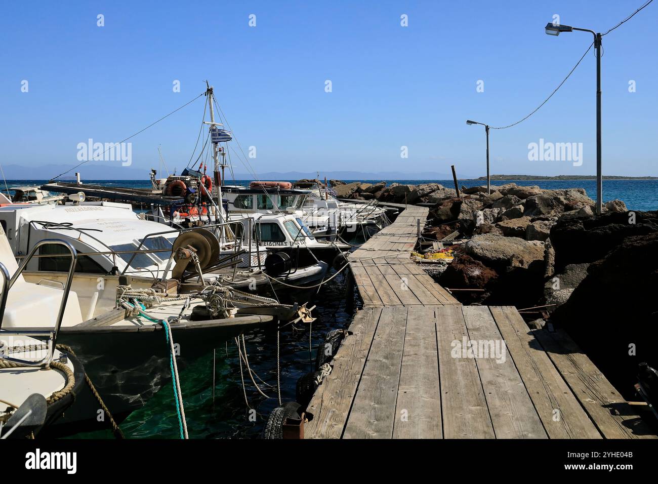 Rickety wooden walkway and local fising boats, Skala harbour, Agistri ...
