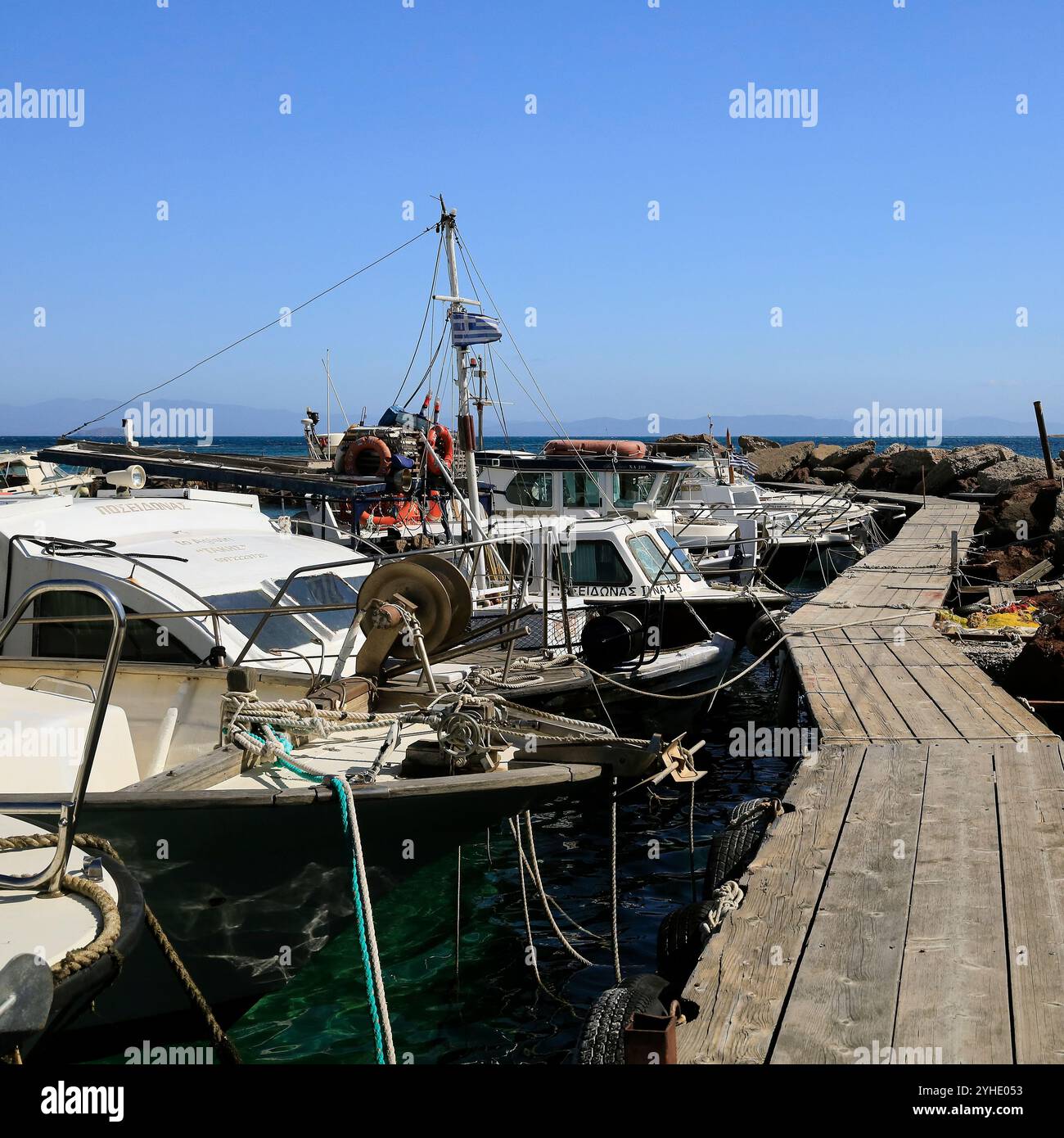 Rickety wooden walkway and local fising boats, Skala harbour, Agistri ...