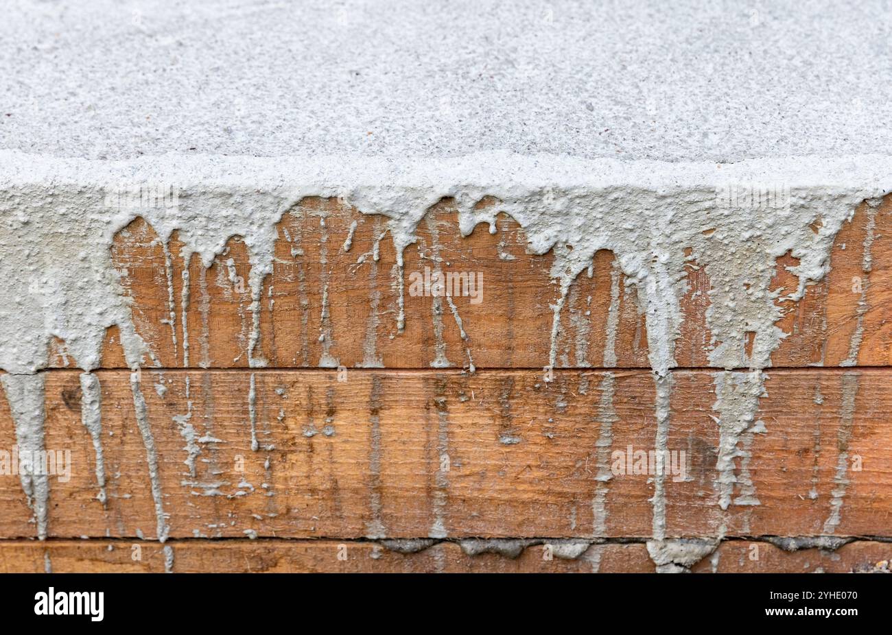 Freshly laid concrete foundation in wooden formwork. Rural house is ...