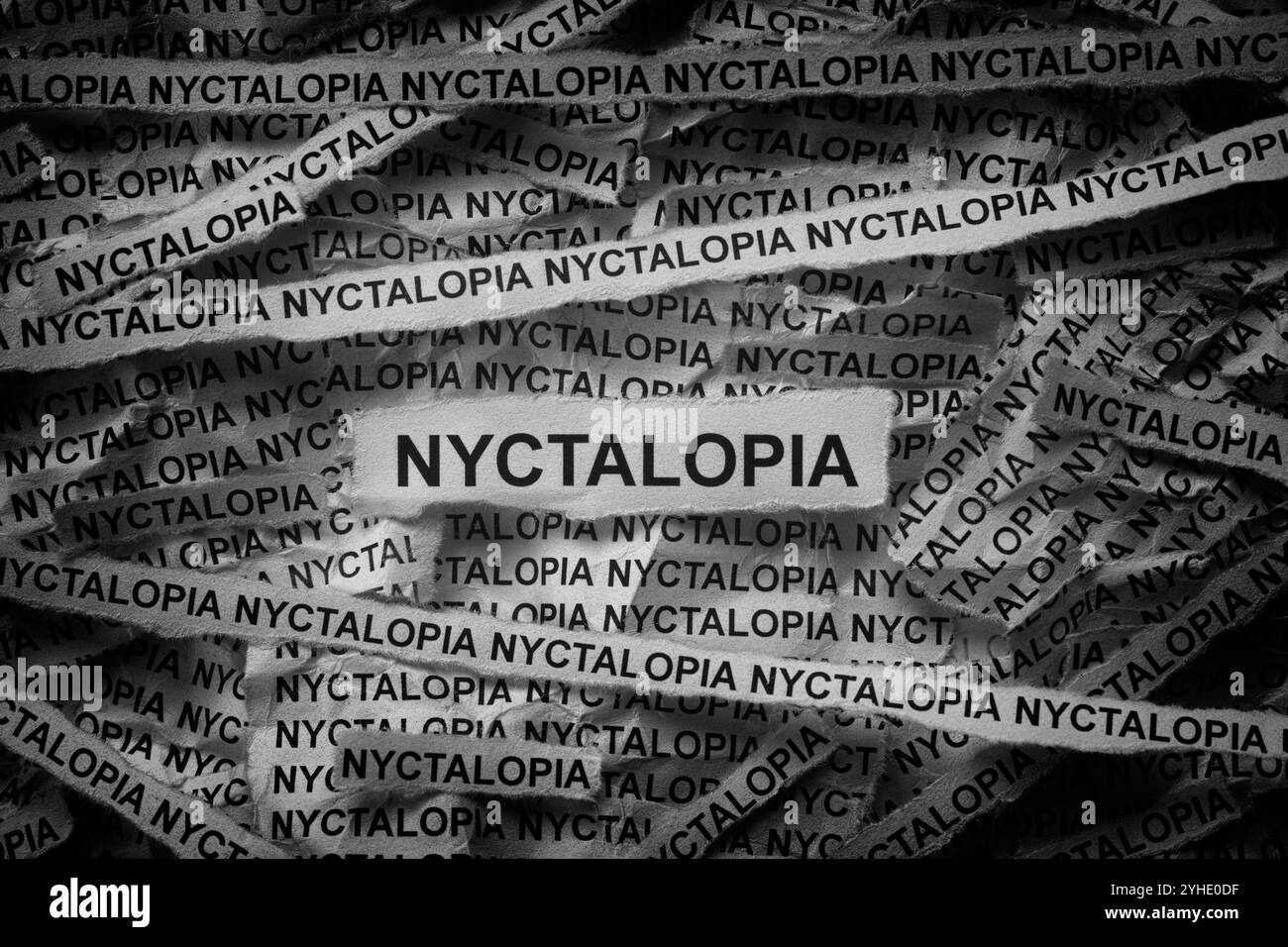Strips of newspaper with the words Nyctalopia typed on them. Black and ...
