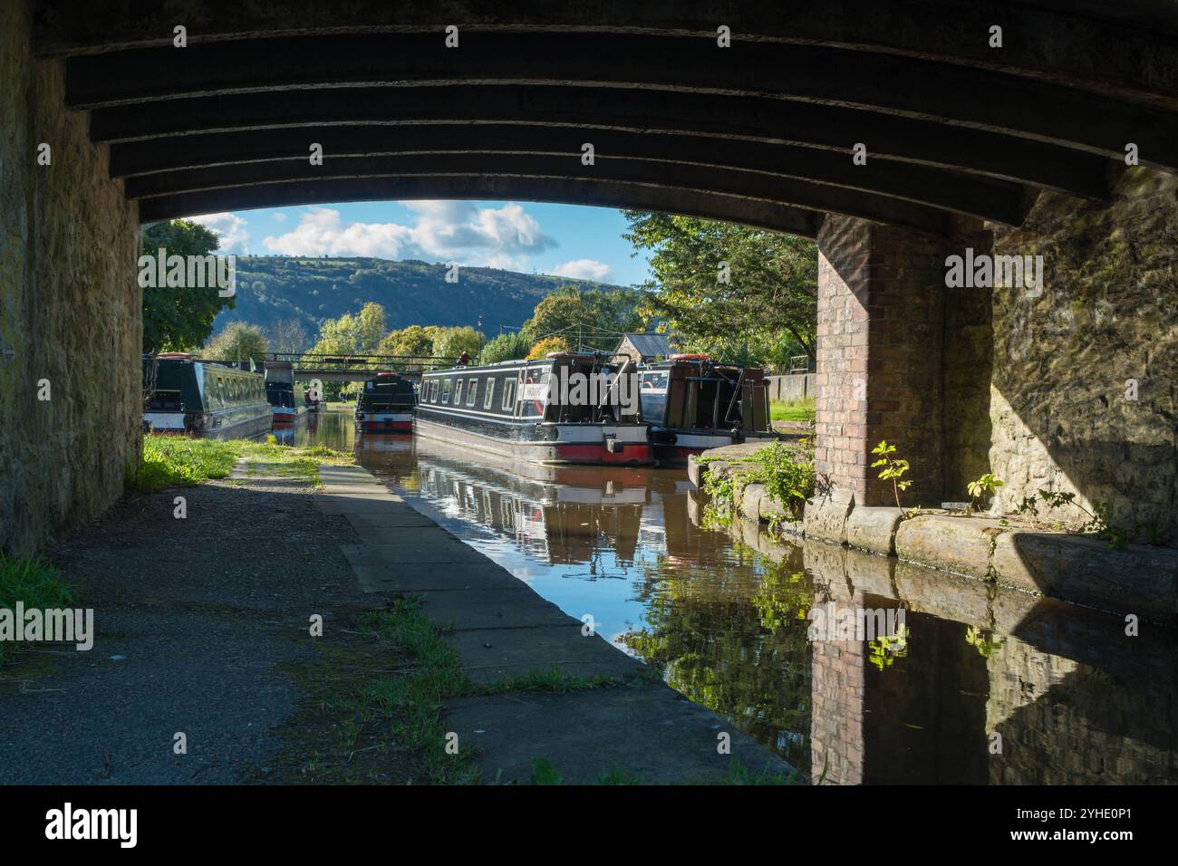 Canal boats moored up at Trevor Basin seen from beneath a bridge ...