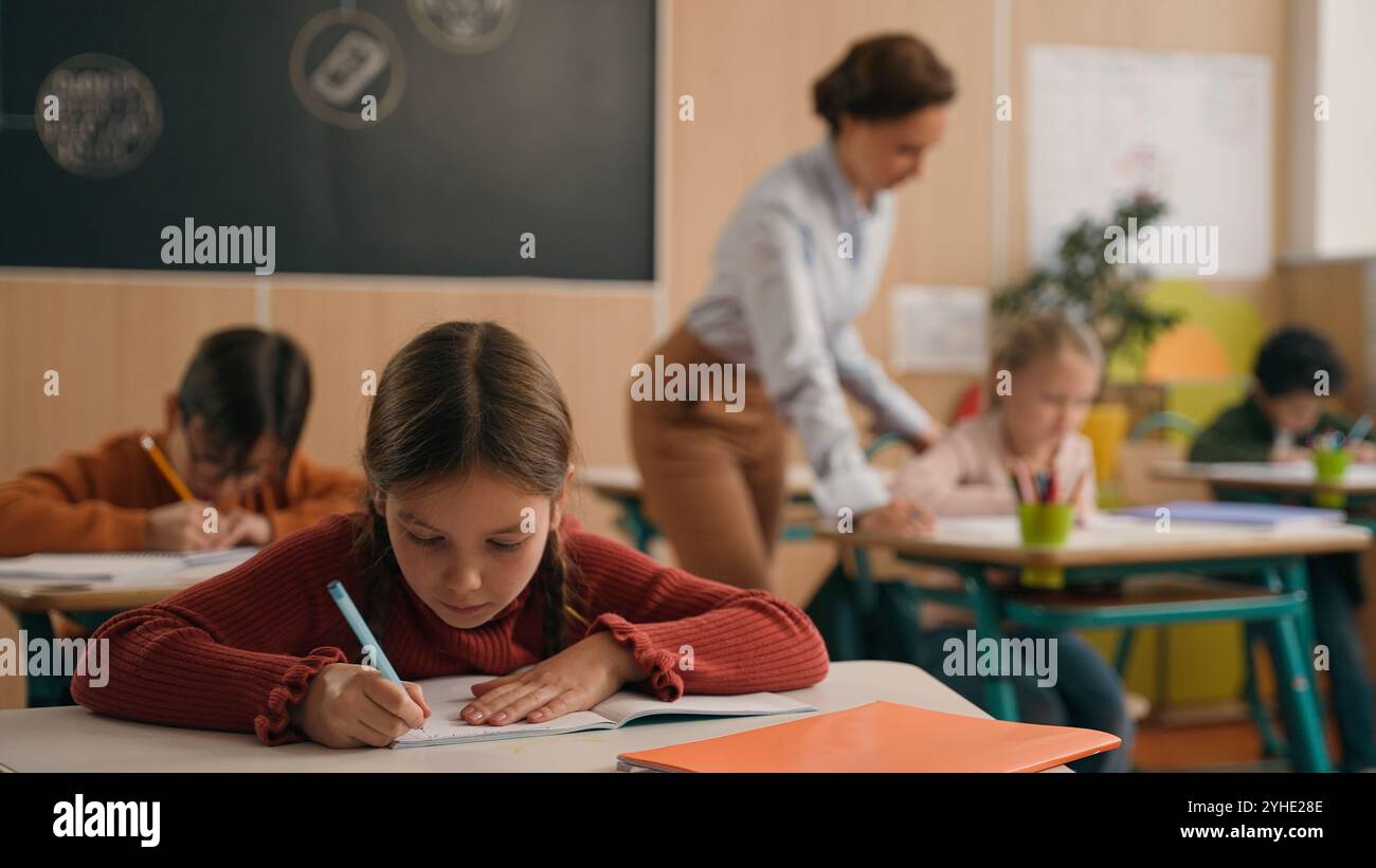 School class lesson children studying learning in classroom woman ...