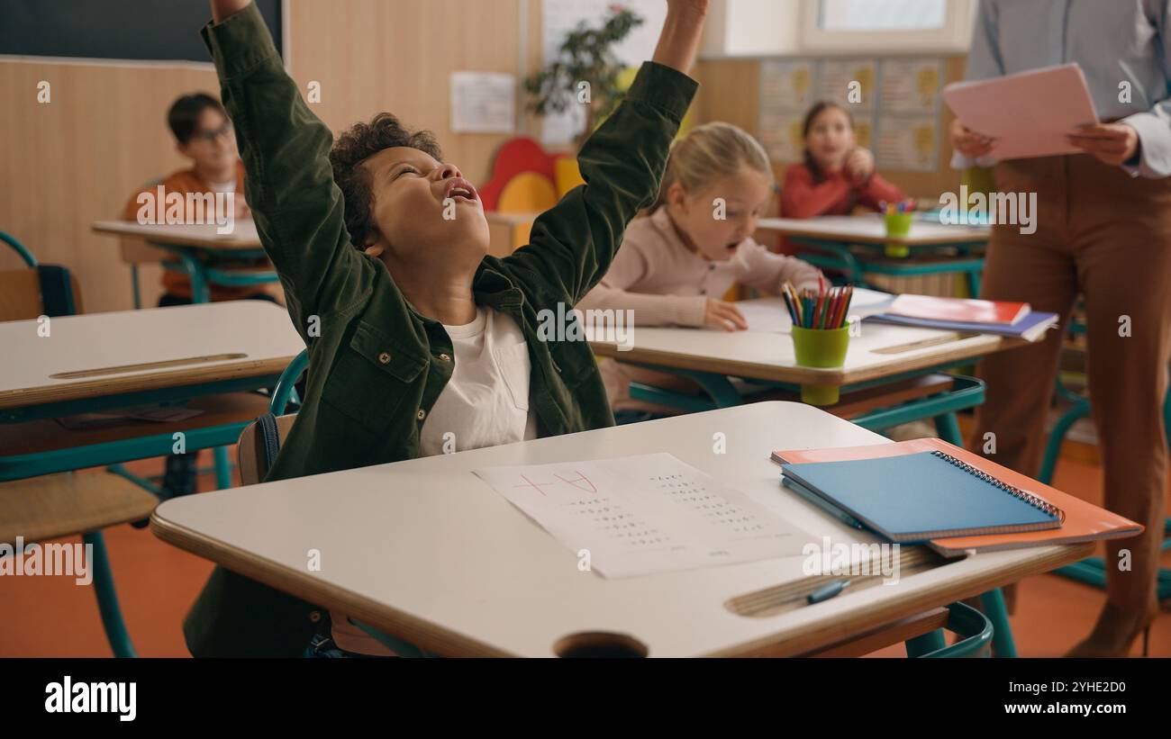 Unrecognizable female teacher give test papers result marks to children ...