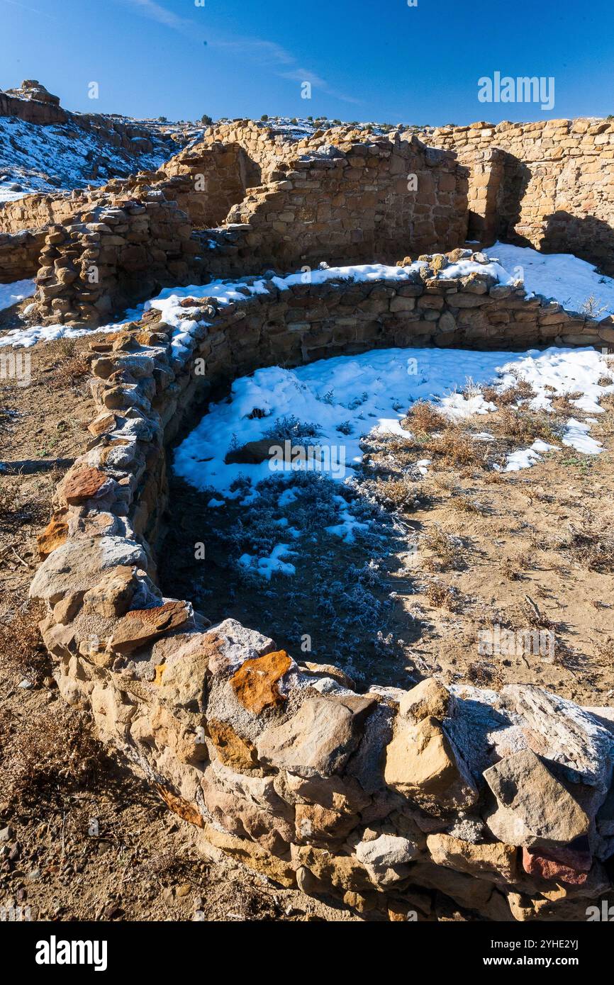 Snow clinging to the shaded areas of a kiva in the Casa Rinconada ruins ...
