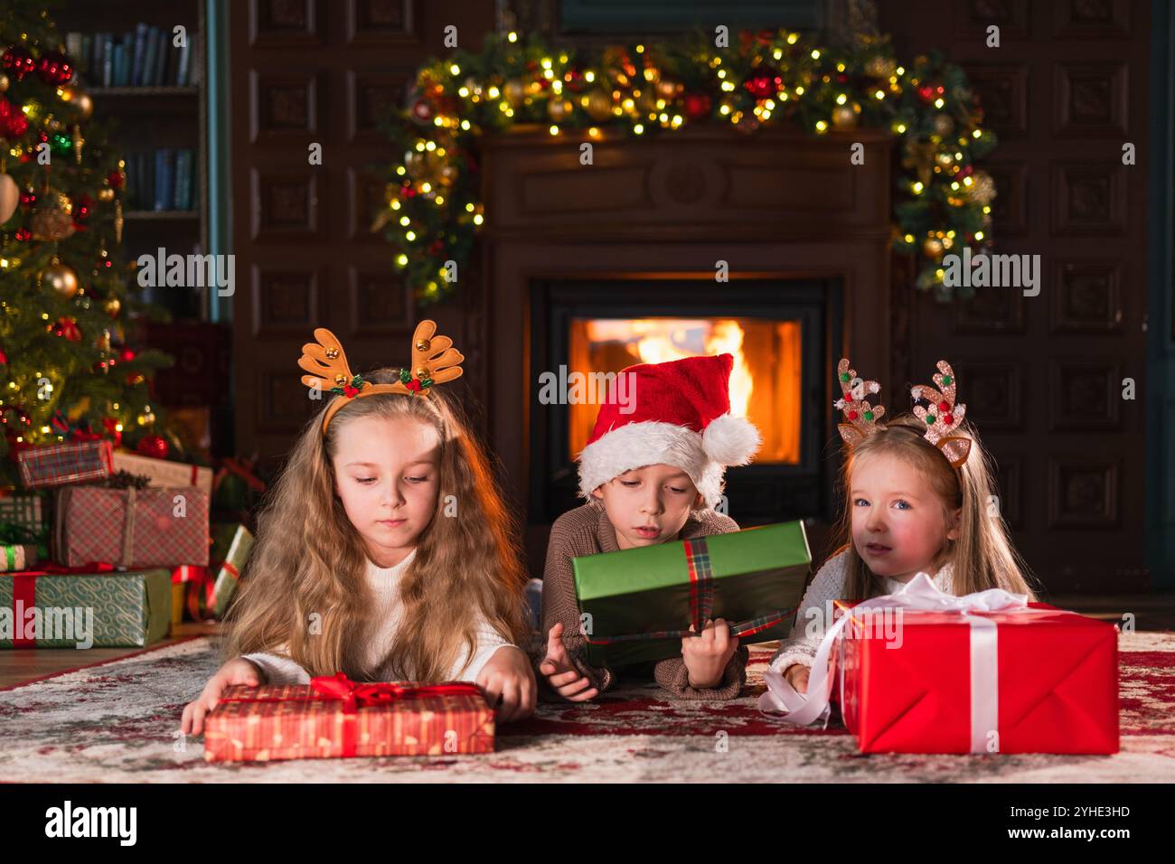 Merry Christmas Xmas holiday. Children unpacking open up gift box near ...