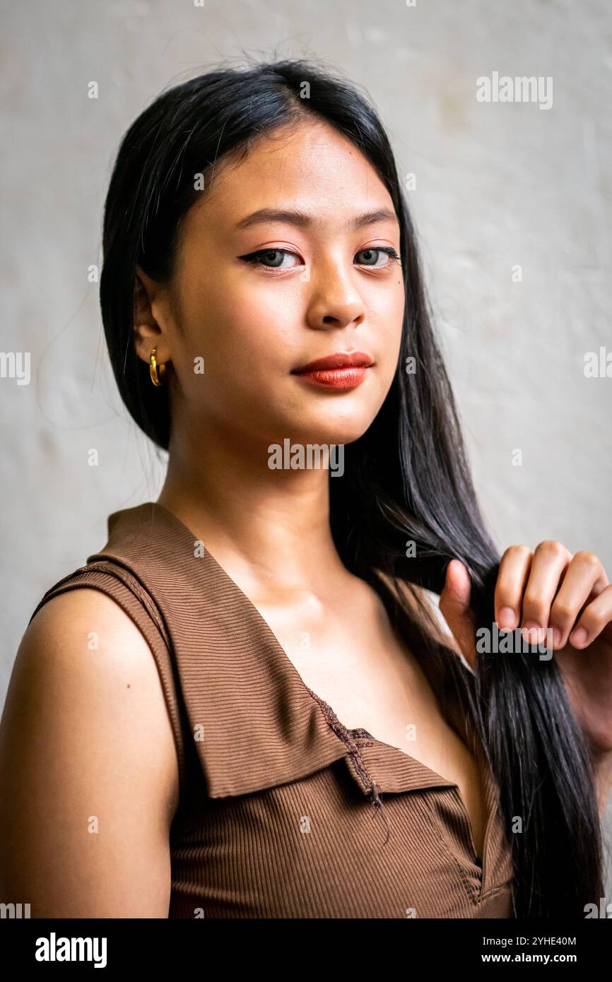 A beautiful young Filipino girl poses and smiles in the Binondo district of Manila, The ...