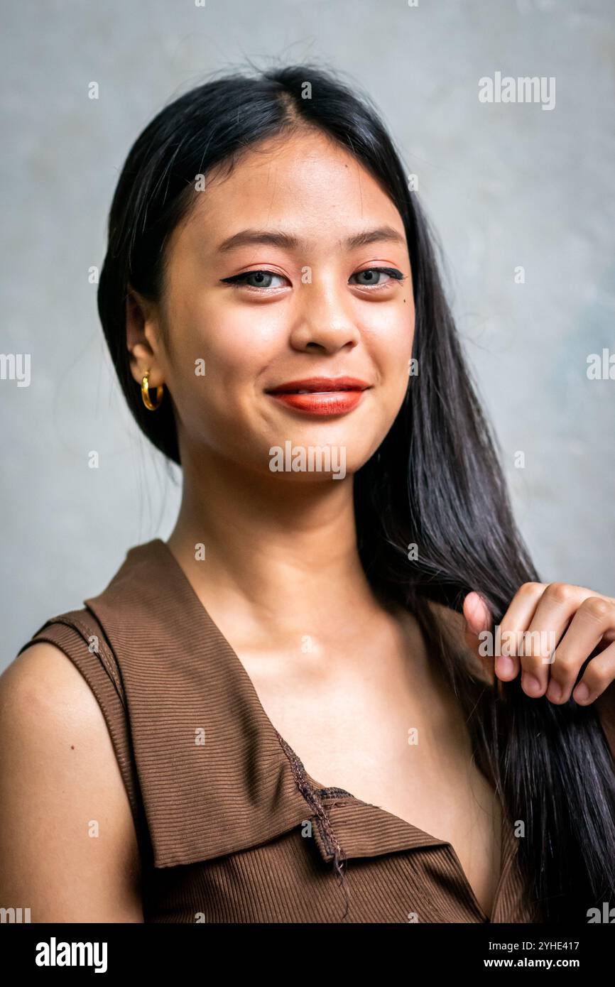 A beautiful young Filipino girl poses and smiles in the Binondo ...