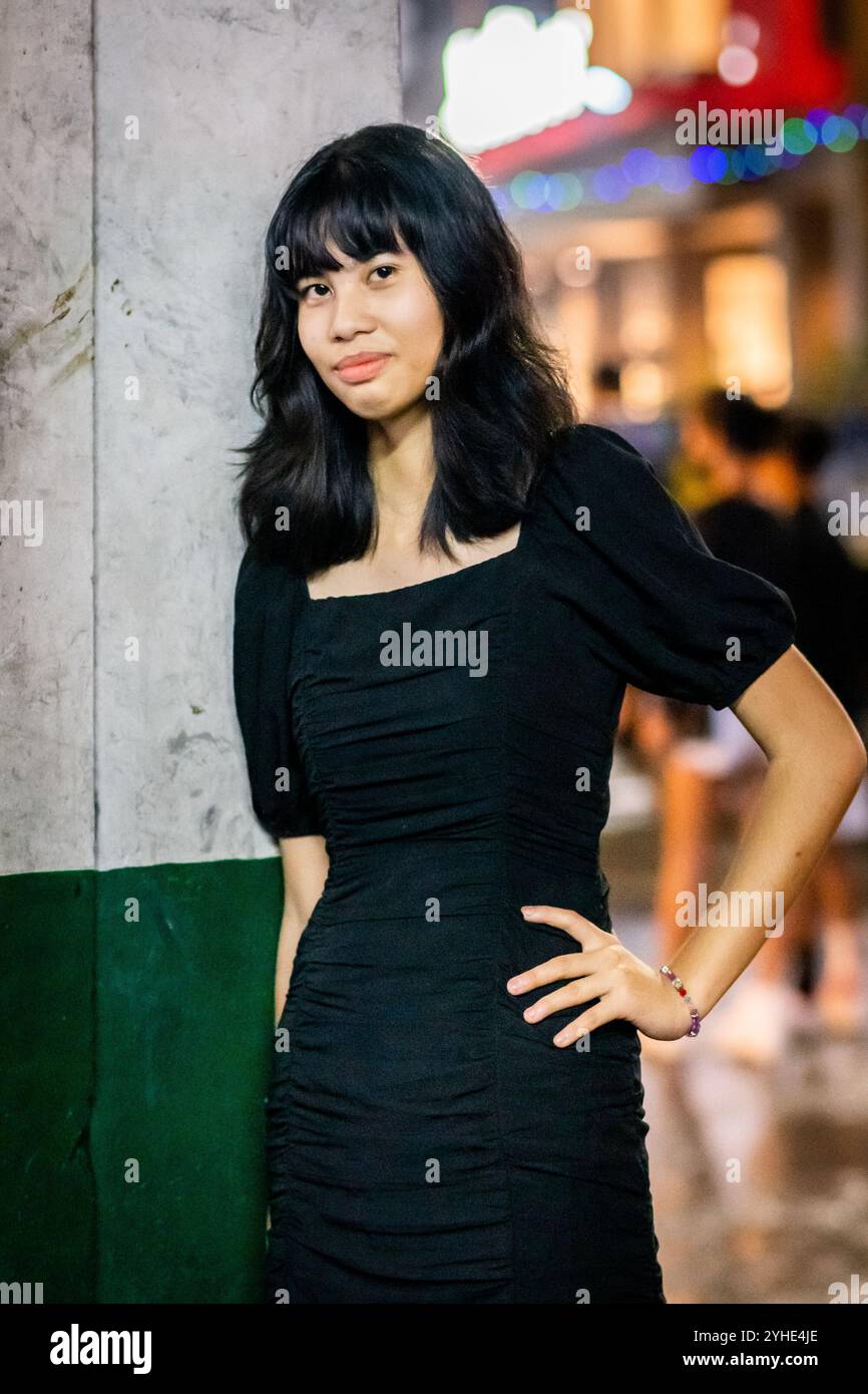 A beautiful young Filipino girl poses and smiles in the Binondo ...
