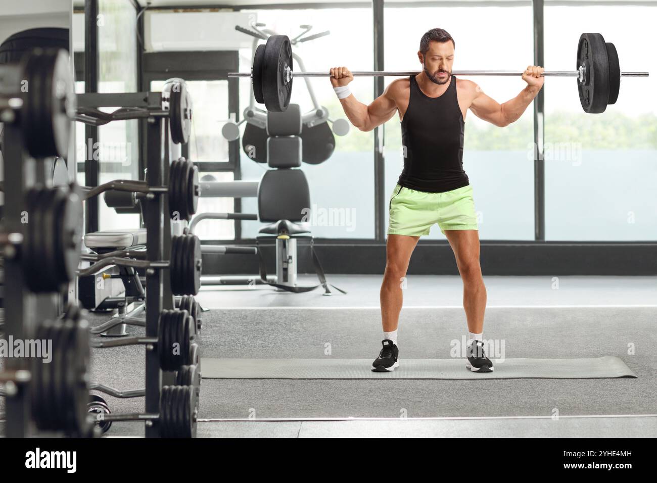 Man lifting weights at a gym Stock Photo - Alamy