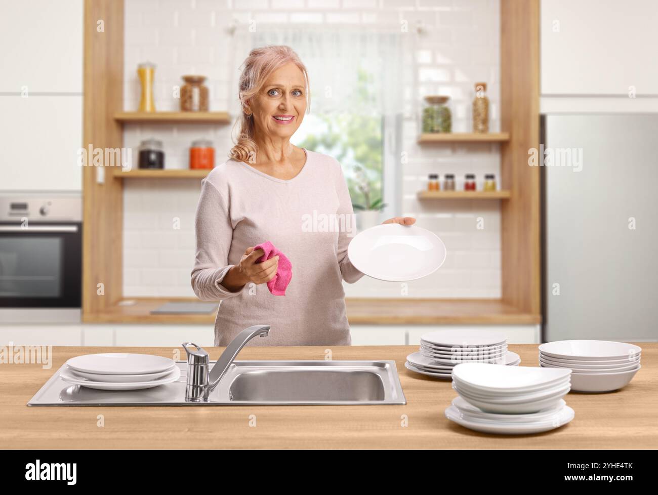 Hand washing dishes in kitchen hi-res stock photography and images - Alamy