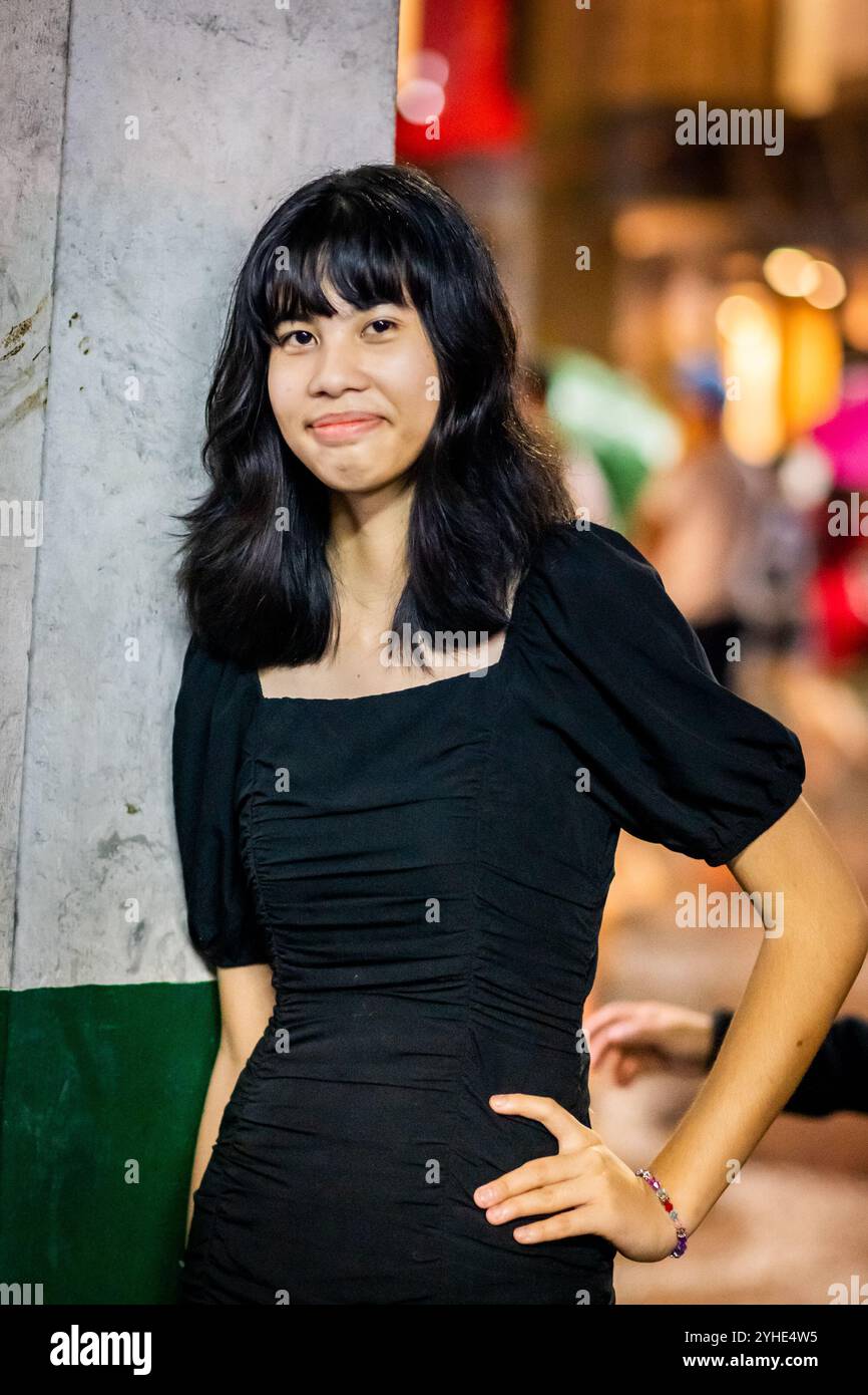 A beautiful young Filipino girl poses and smiles in the Binondo district of Manila, The ...