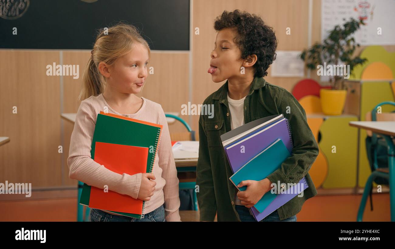 Two happy naughty pupils children diverse multiethnic kids African ...