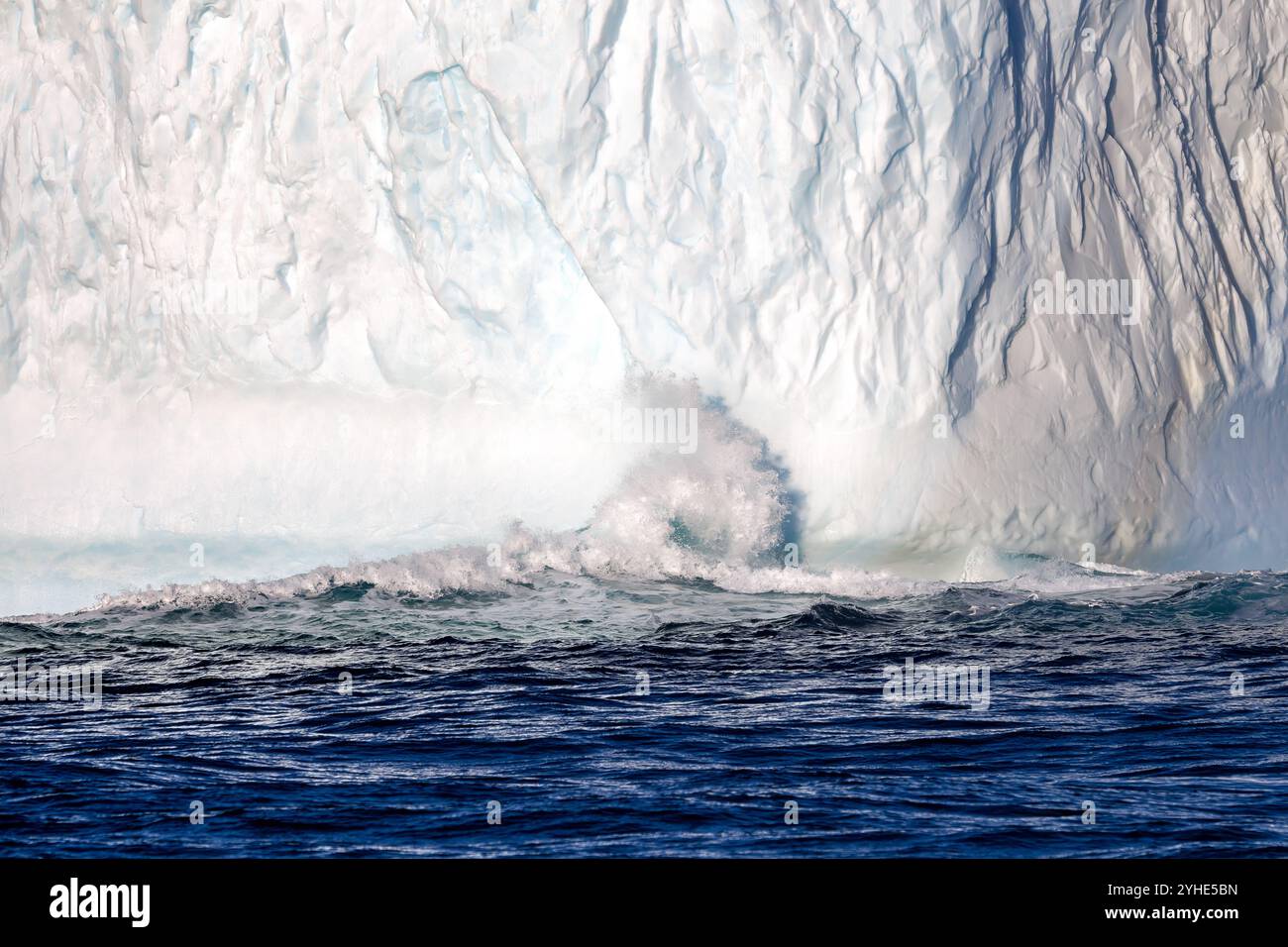 Wave crashes into a huge iceberg in Liverpool Land, Greenland. This is ...