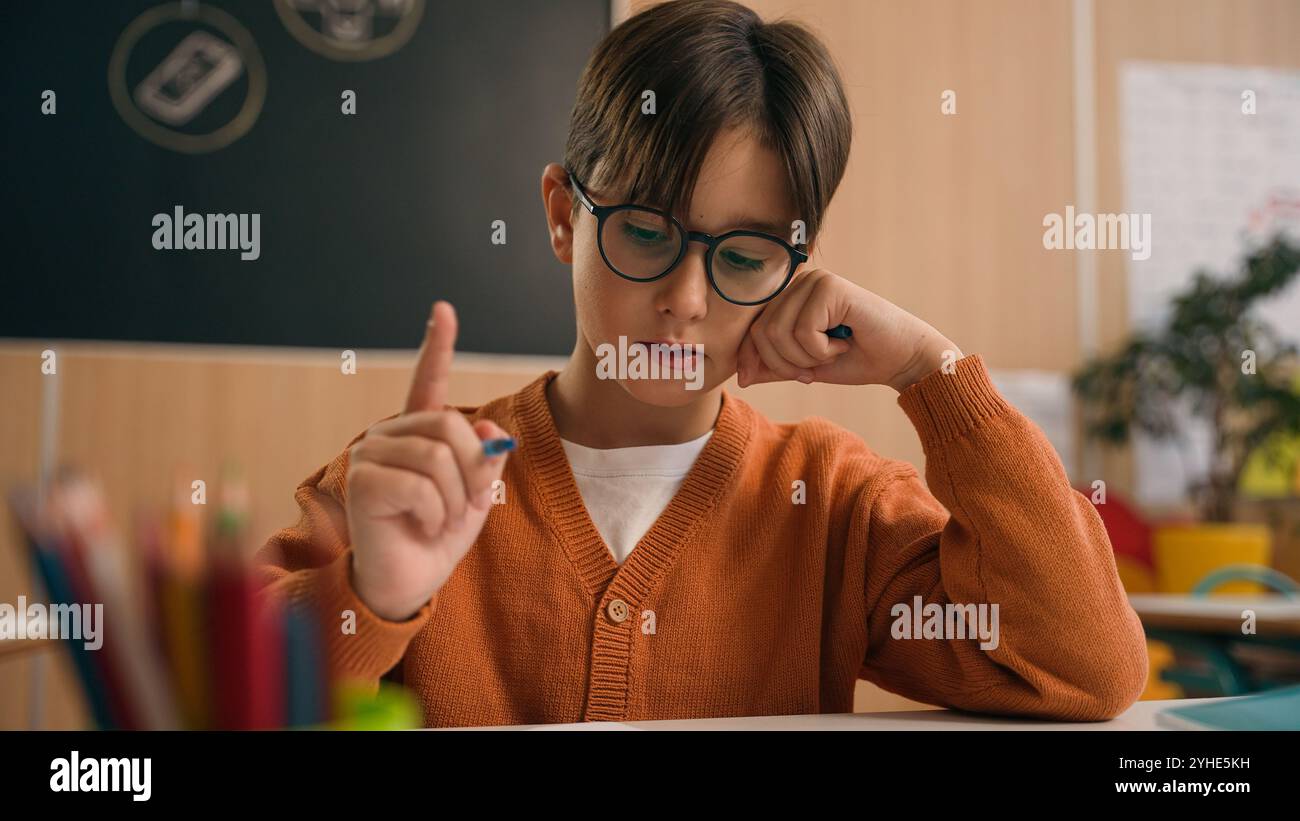 Caucasian guy boy think find idea ponder difficult task writing notes ...