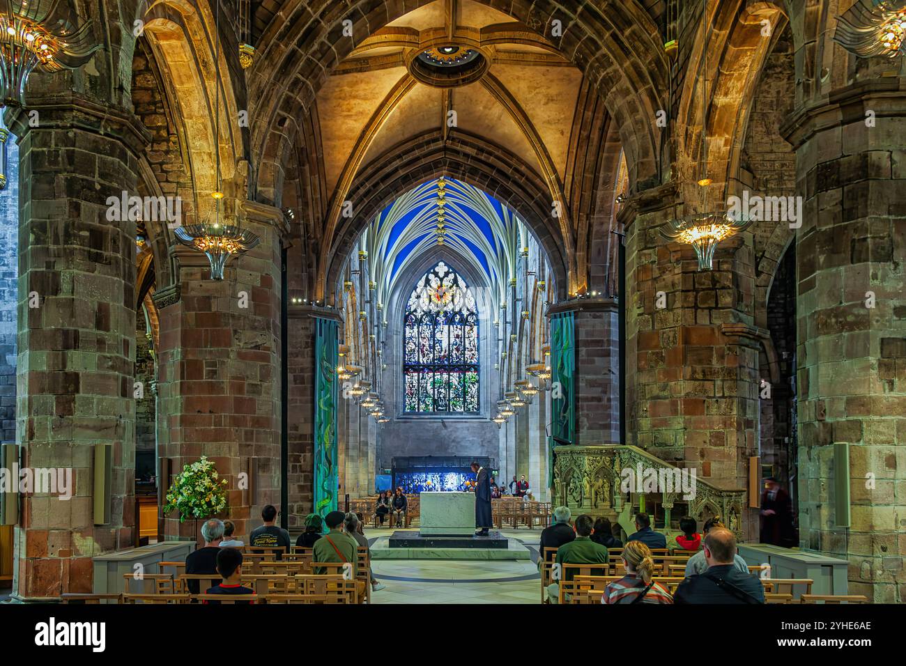 The Gothic interior with stained glass windows and round arches of St ...