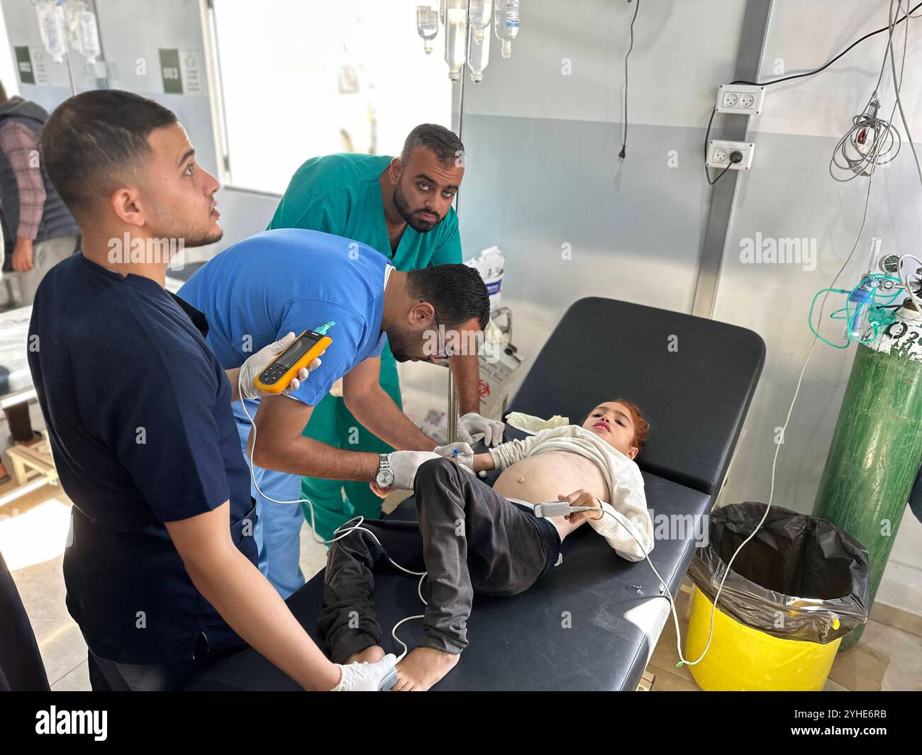 A health officer treats a Palestinian child, injured during Israeli ...