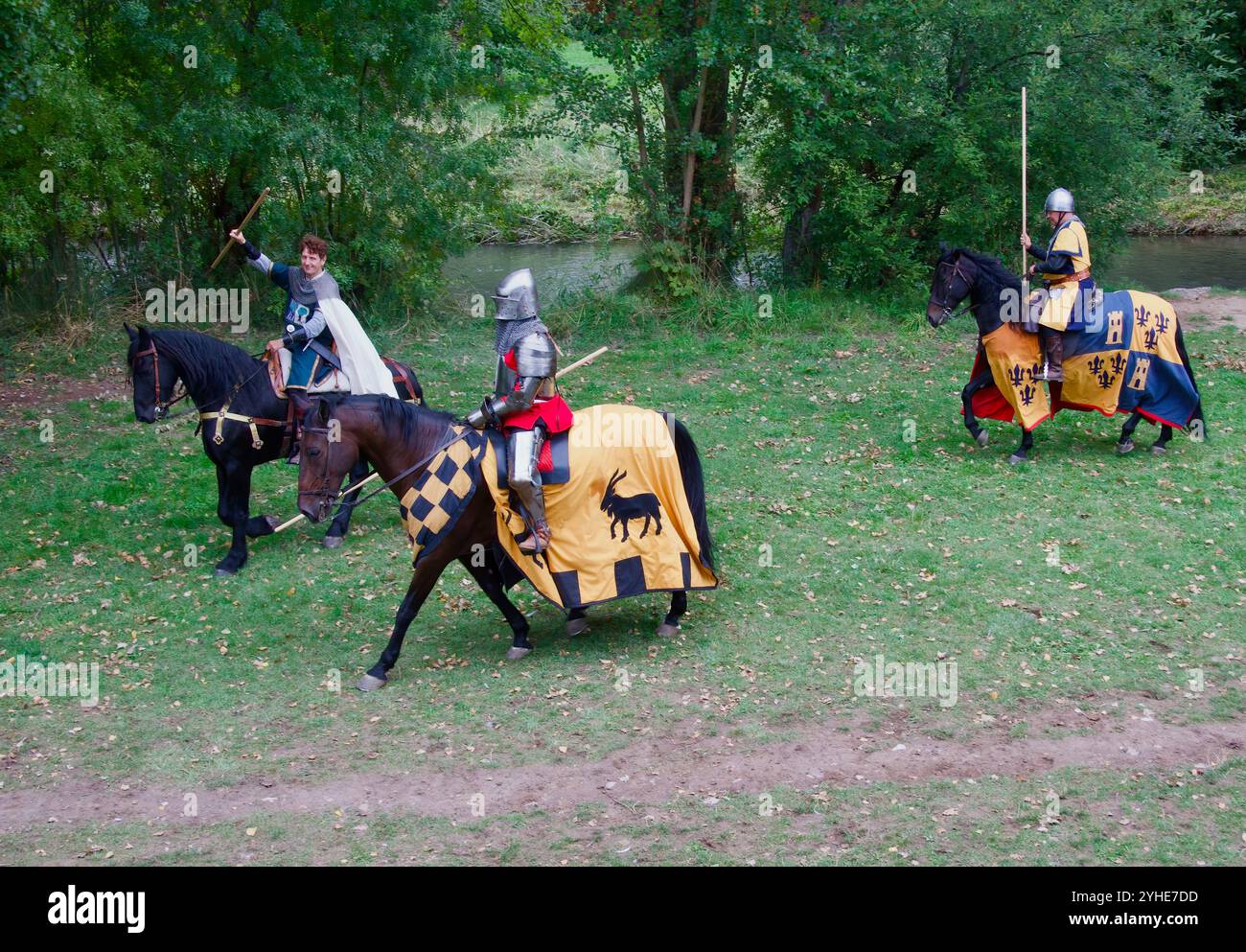 Participants in medieval costumes riding caparisoned horses during a ...