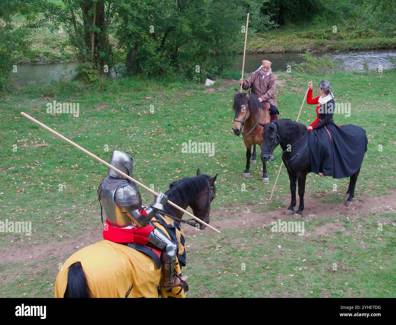Participants in medieval costumes riding caparisoned horses during a ...