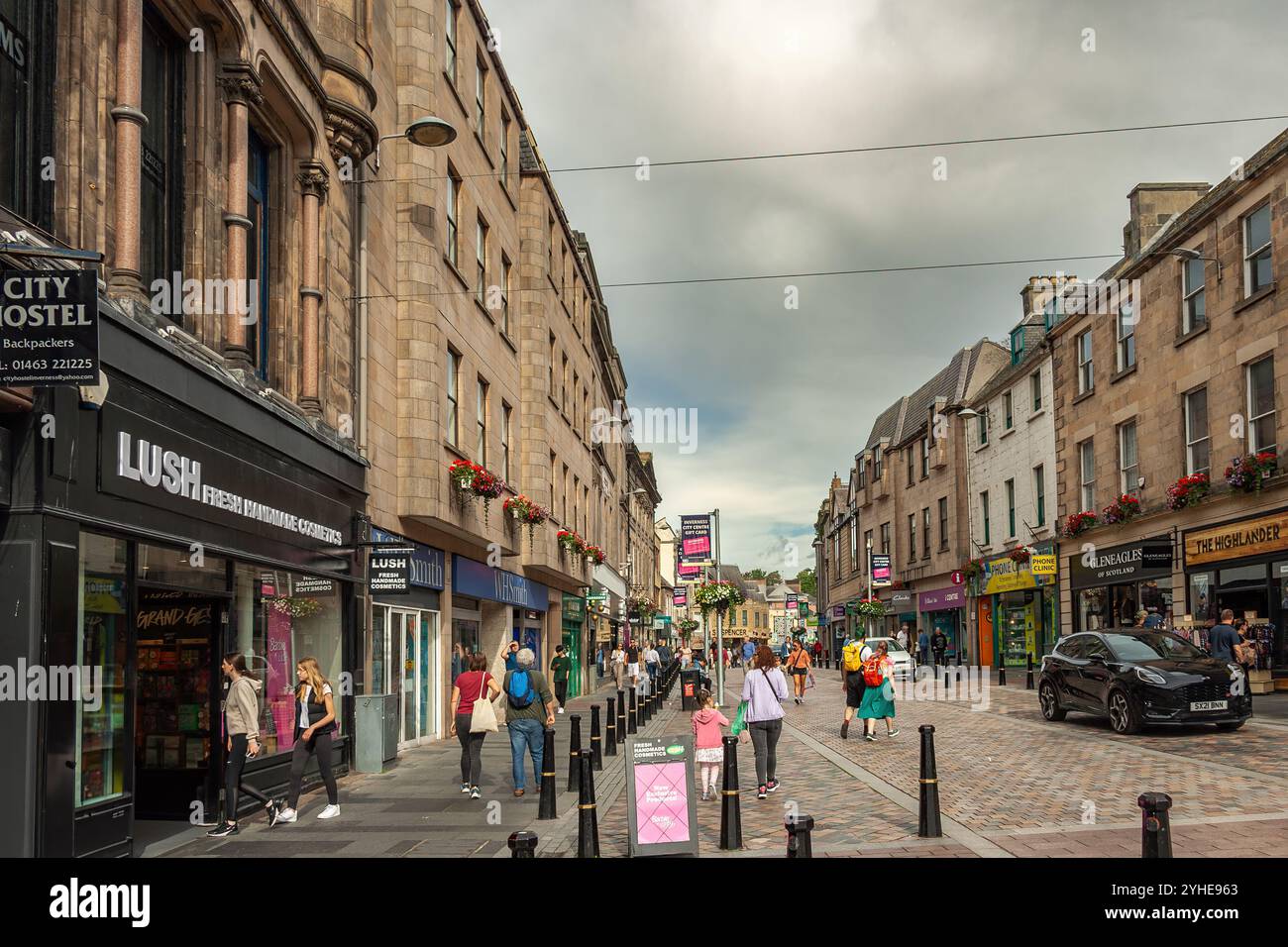Pedestrian street with tourists and residents in the city of Inverness ...