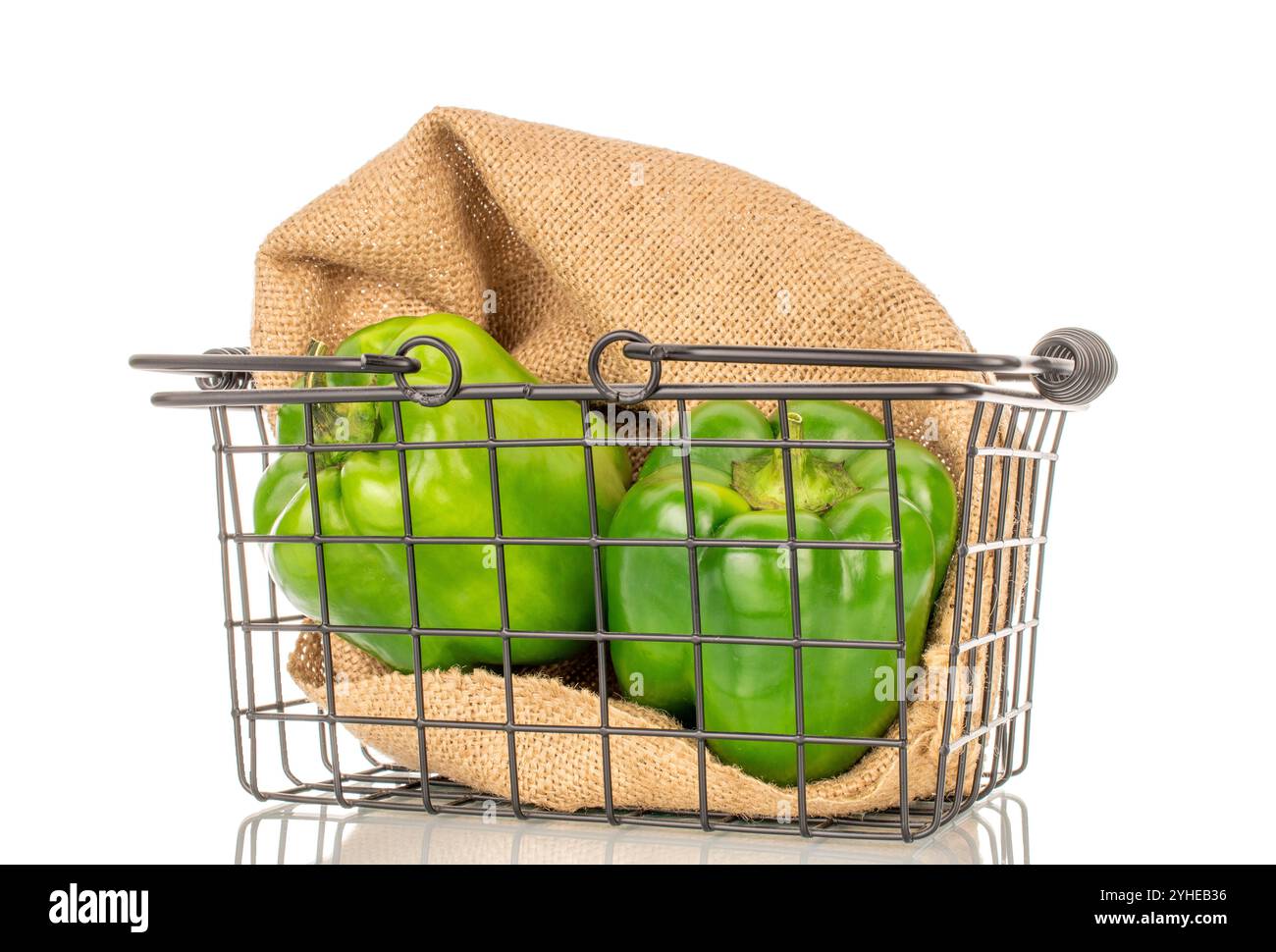 Sweet green capsicum in a basket, macro, isolated on white background ...