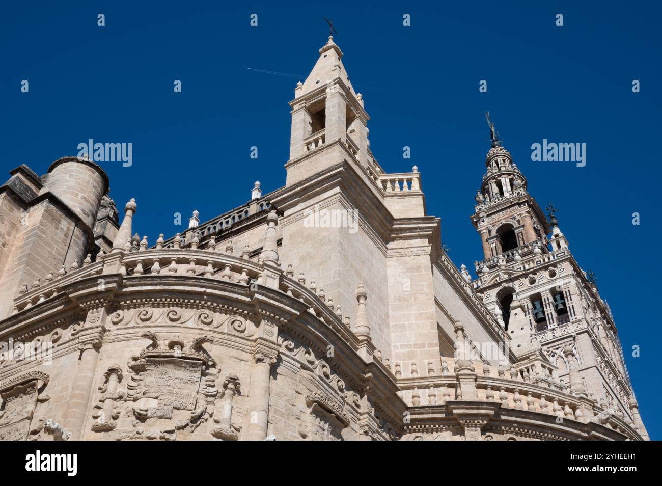 The towering spire of a historic cathedral rises against a clear ...