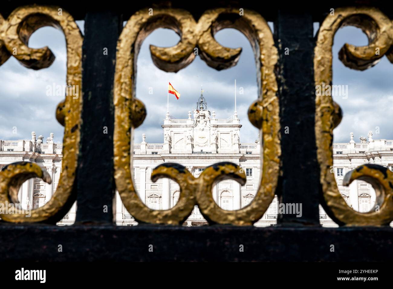 Through the ornate gilded railing, a majestic view of a historic royal ...