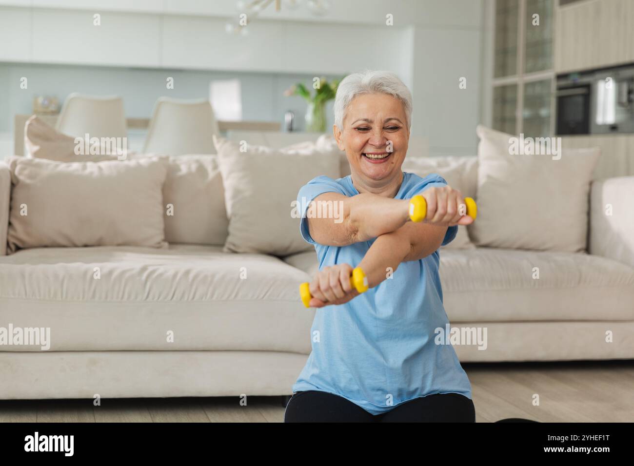 Fitness workout training. Senior woman picking up dumbbells. Old adult ...