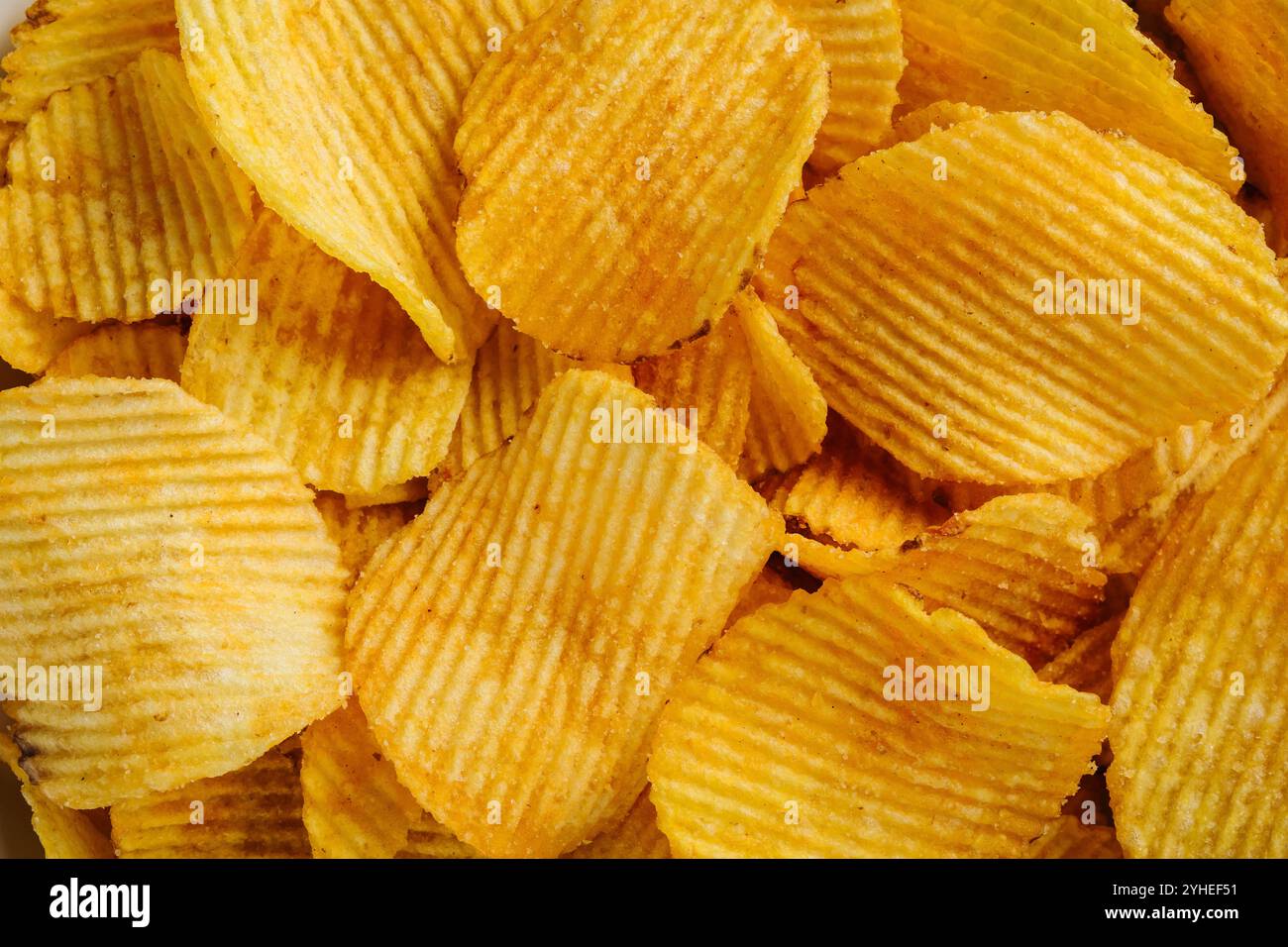 Wavy potato chips close-up, texture, background Stock Photo - Alamy