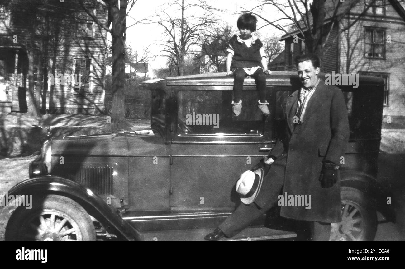 Dad shows off the family car with his daughter on top, c. 1928 Stock ...