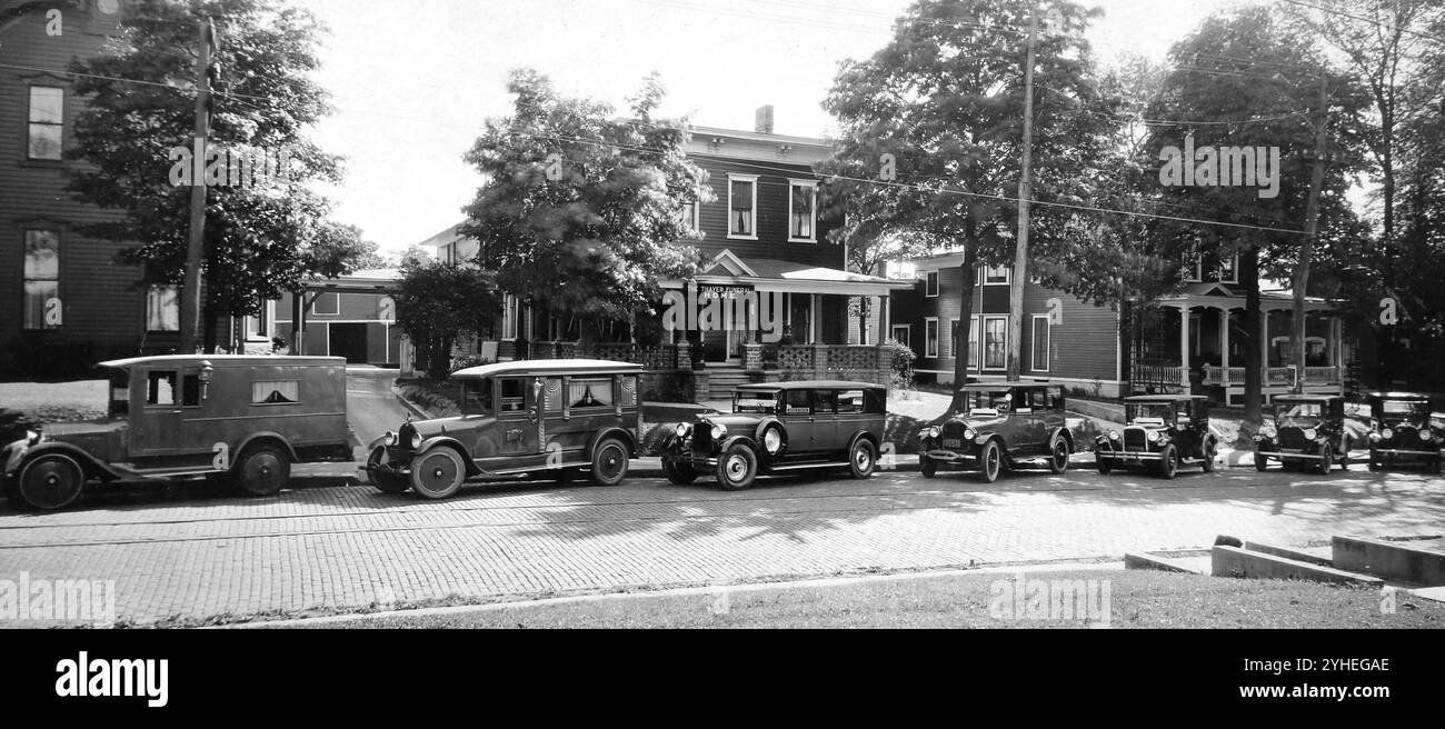 Cars and hearses are lined up on the street outside of an Indiana ...