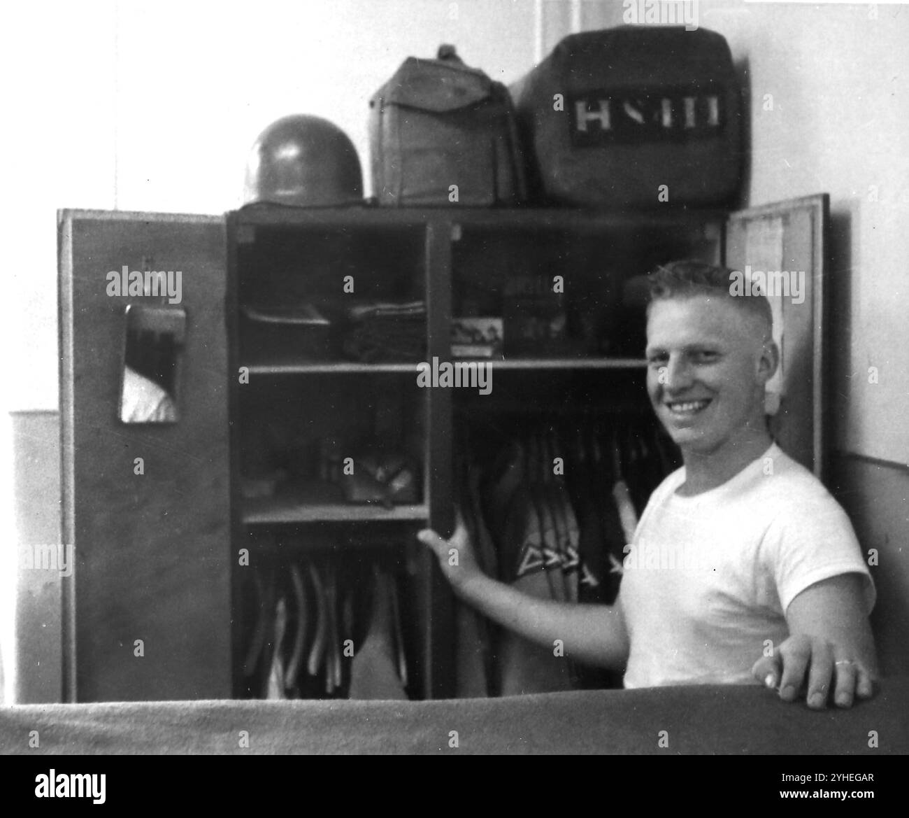 U.S. Service member shows off his barracks locker in German, ca. 1955 ...