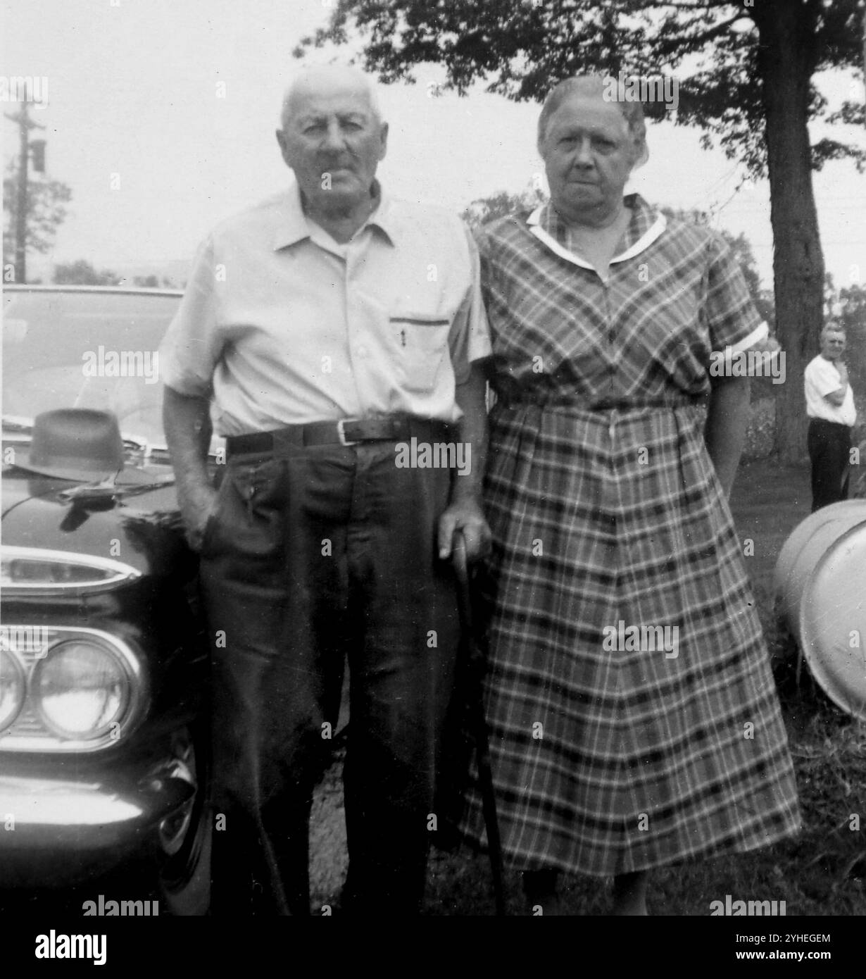 Ma and Pa look unhappy for a portrait by their car, ca. 1960 Stock ...