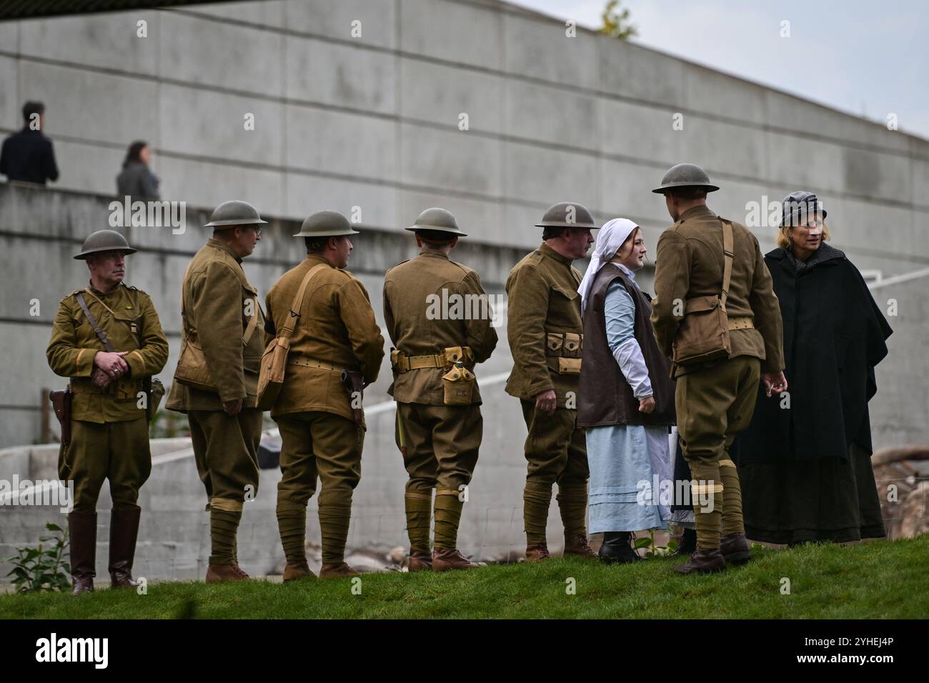 Paris, France. 11th Nov, 2024. Visitors wearing WWI uniforms look on as ...
