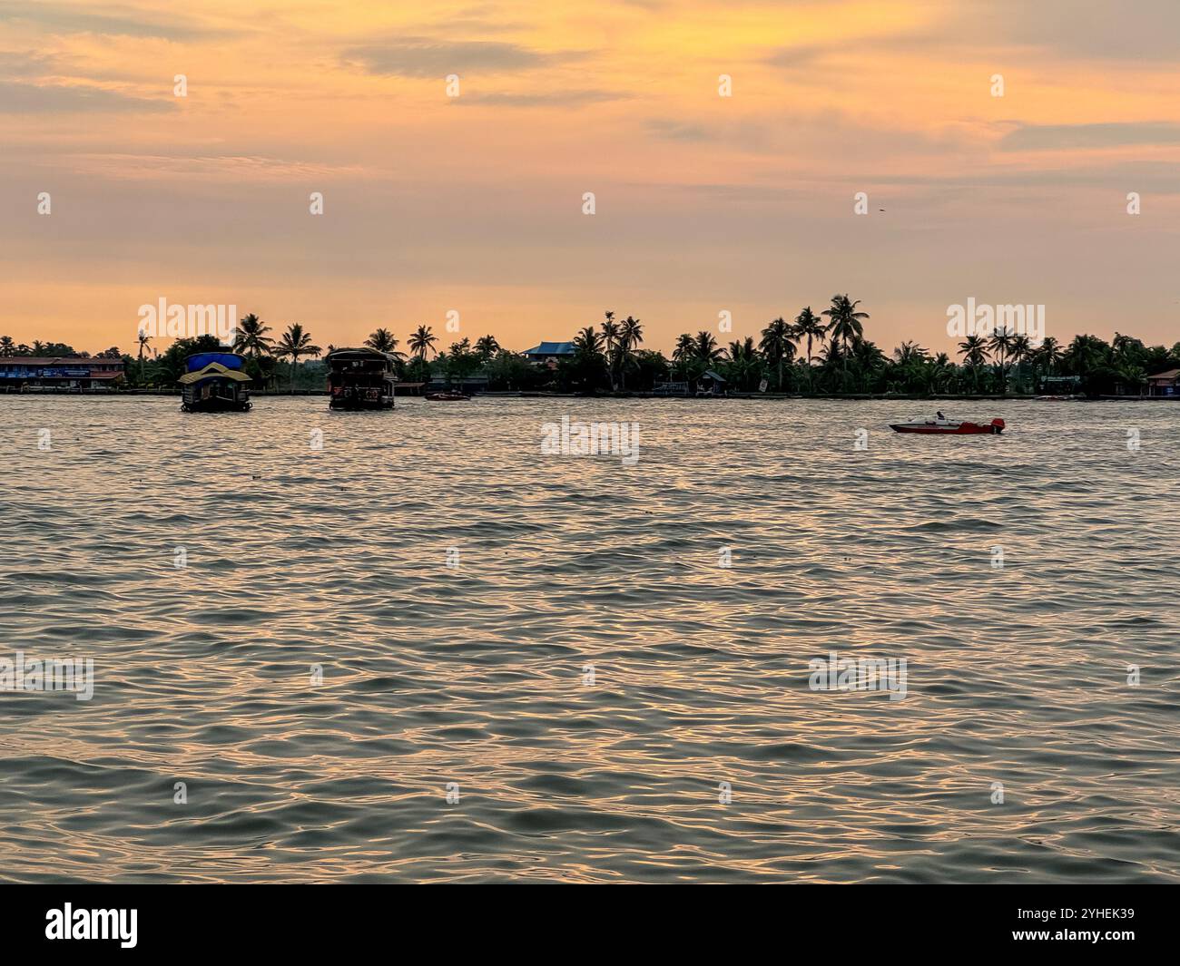 Alleppey, Kerala, India - May 15 2024: Sunset experience during houseboat cruise through the ...