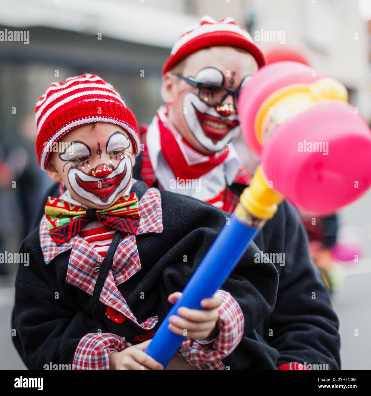A father and son dressed as clowns have fun at an event in Germany ...