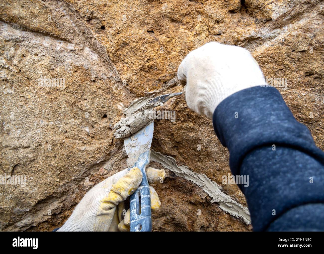 Forming a decorative joint in masonry made of stone blocks Stock Photo ...