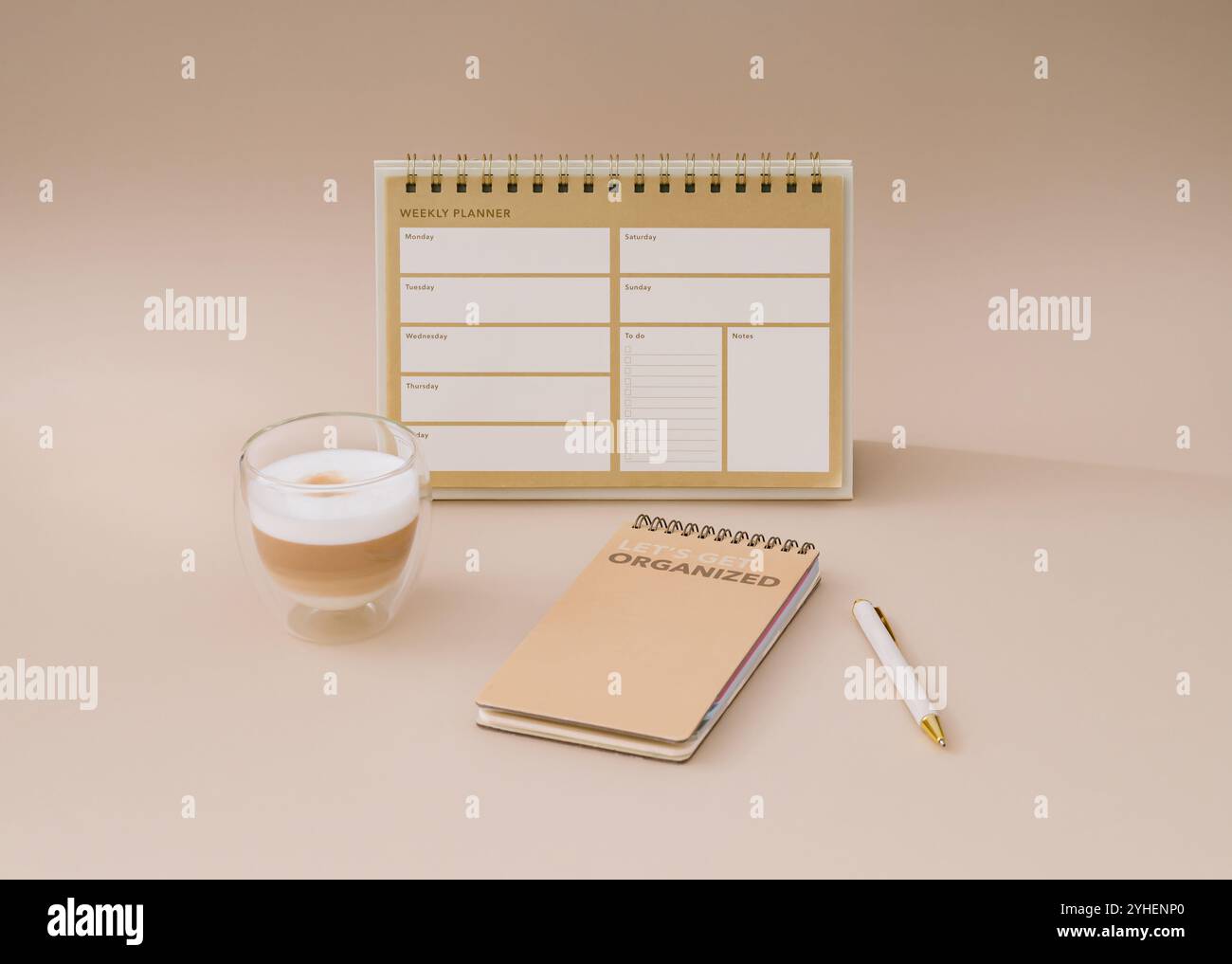 Trendy layout with weekly planner, coffee and pen on beige background ...