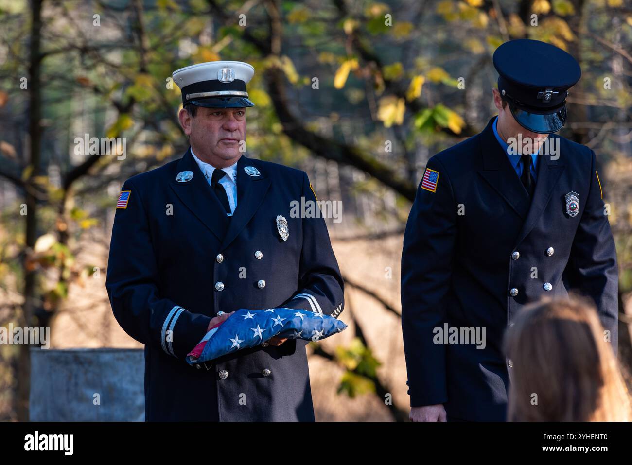 Concord firefighter David Curran waiting with a folded flag to be ...