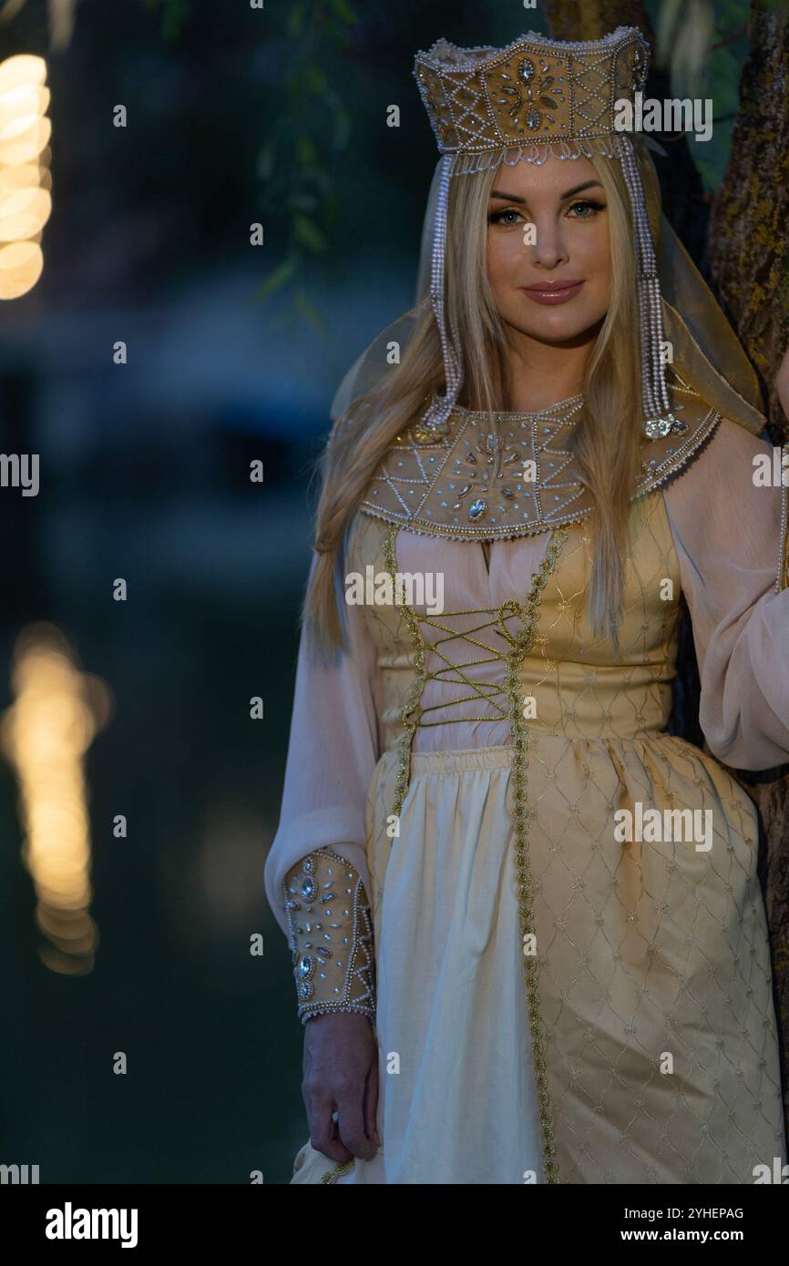 Portrait of a beautiful girl wearing a kokoshnik (crown) and ...