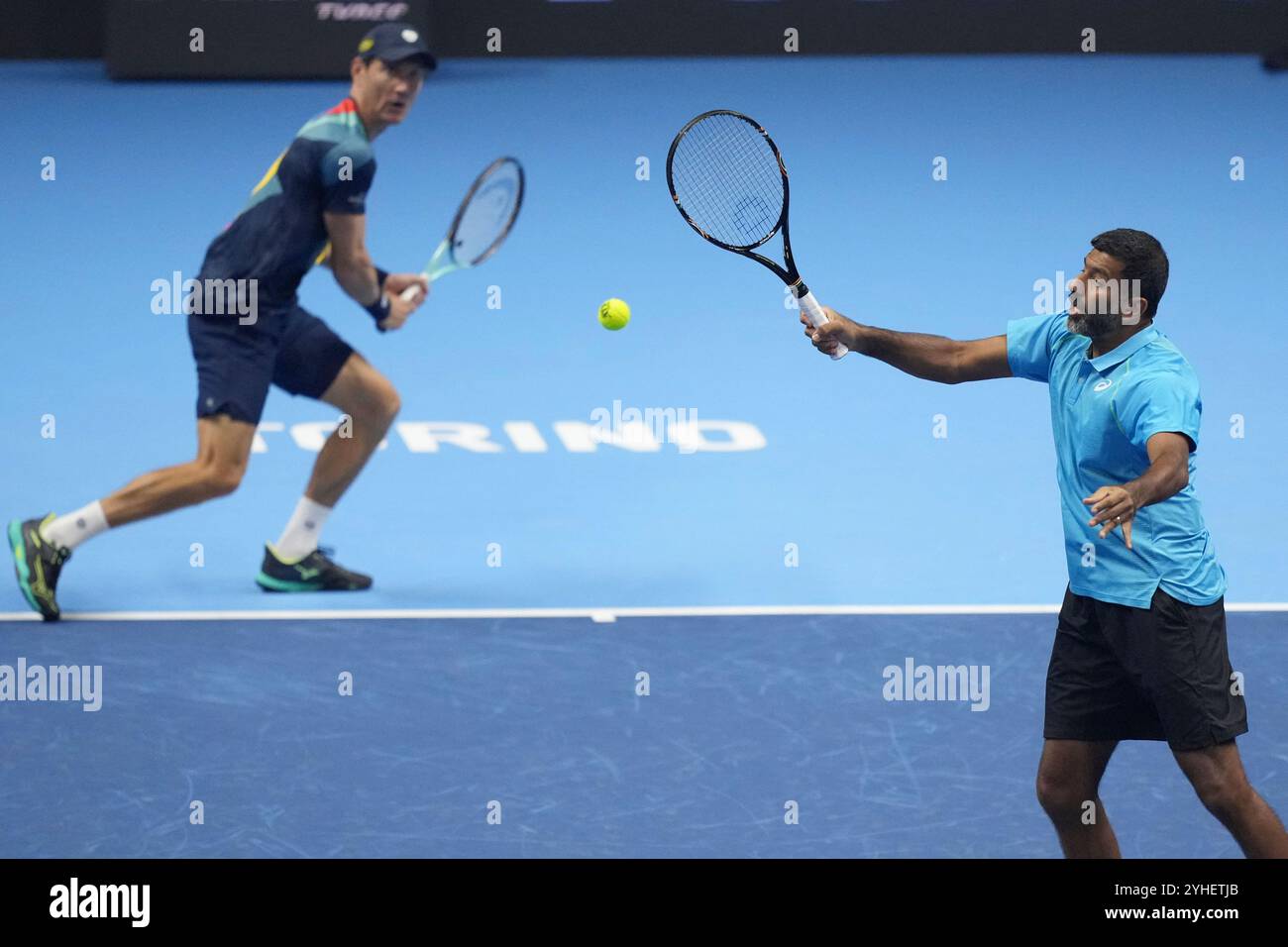 India's Rohan Bopanna, right, and Australia's Matthew Ebden return the ball to Italy's Simone ...