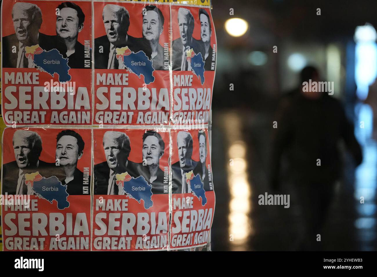 A man walks by posters show U.S. President-elect Donald Trump, left ...