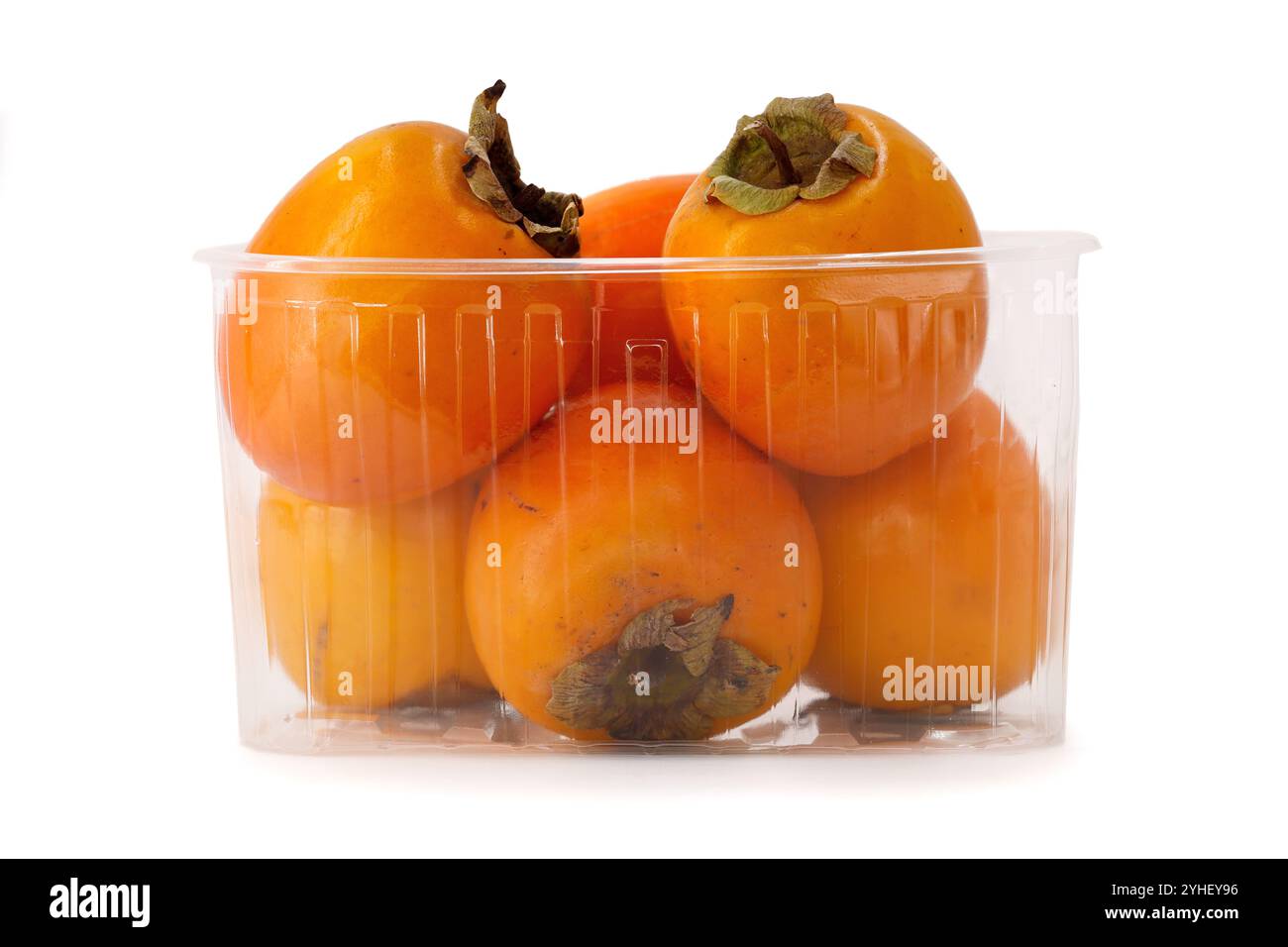 Kaki of the Rojo Brillante variety in a plastic container isolated on ...