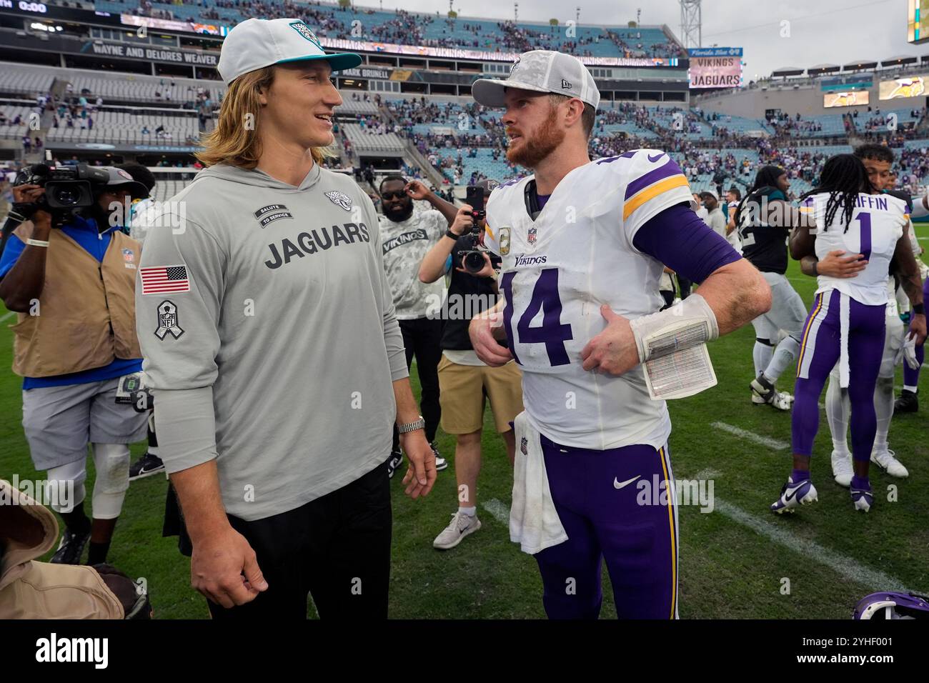 Jacksonville Jaguars quarterback Trevor Lawrence, left, greets ...
