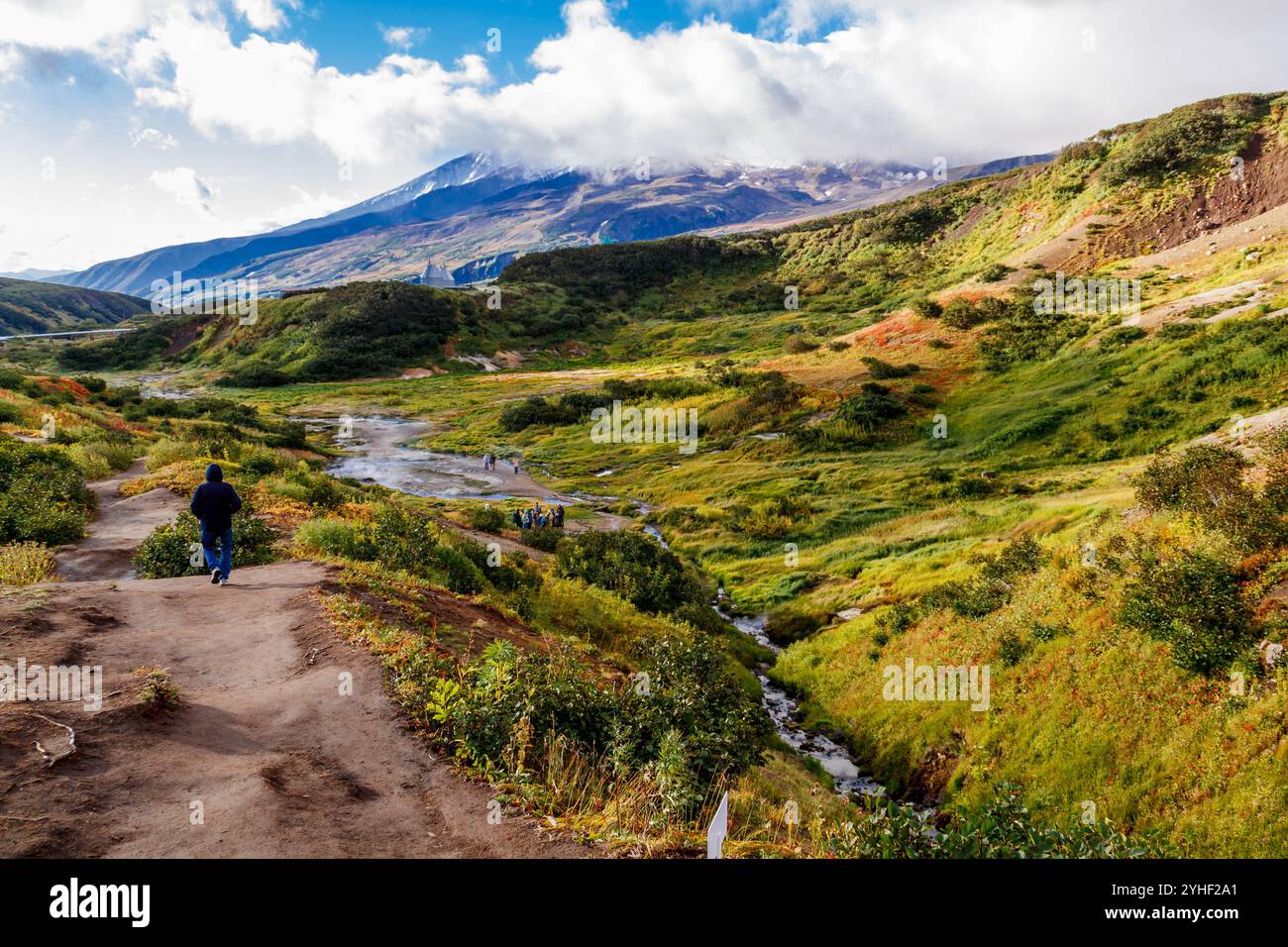 View of mountain valley. Steam over a natural hot geothermal spring ...