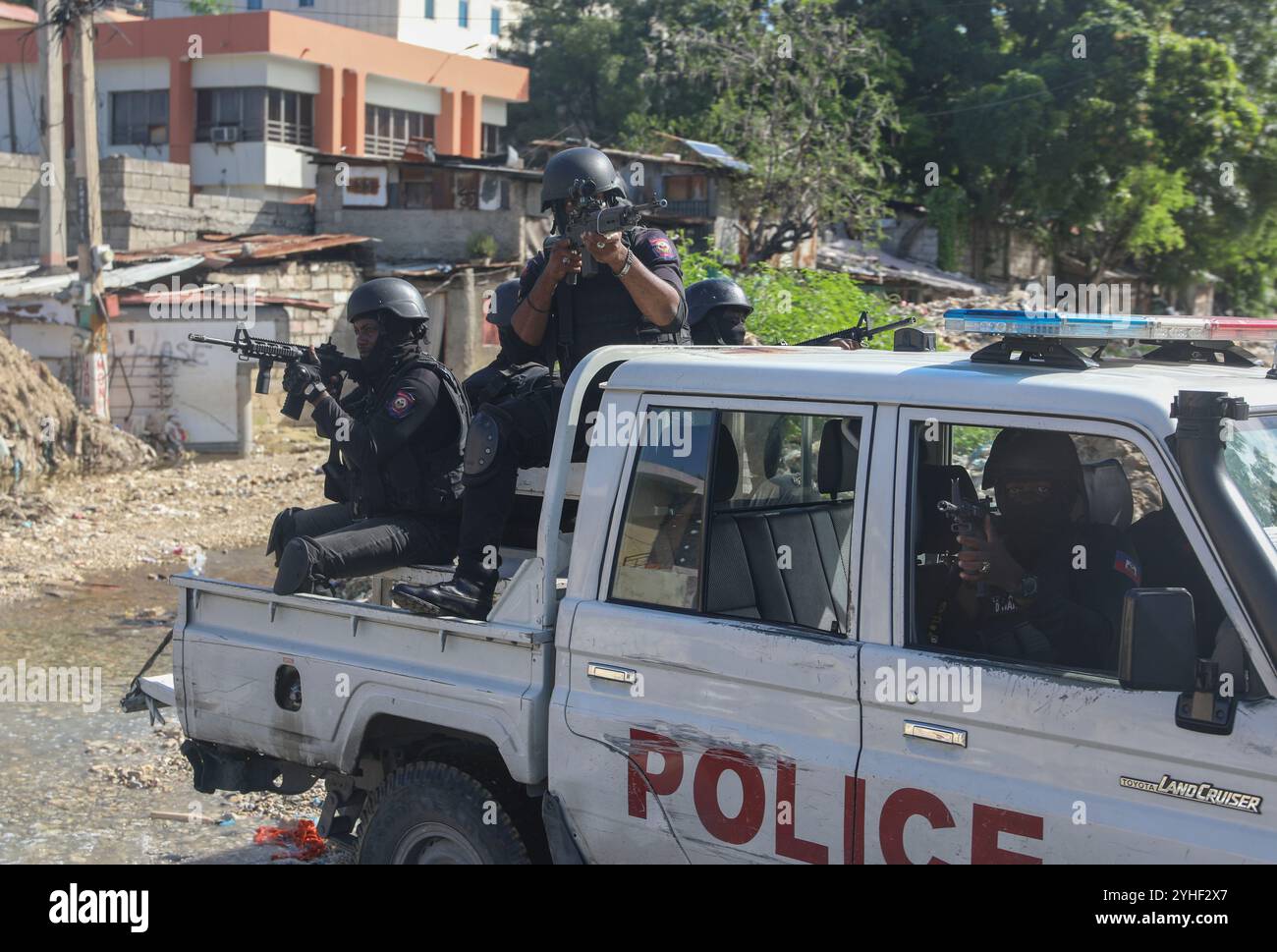 Police officers patrol the area during an exchange of gunfire between ...