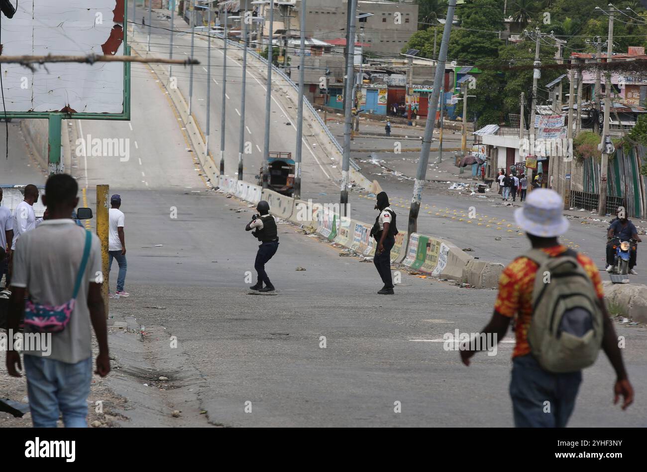 People watch as police officers exchange gunfire with gangs in Port-au ...