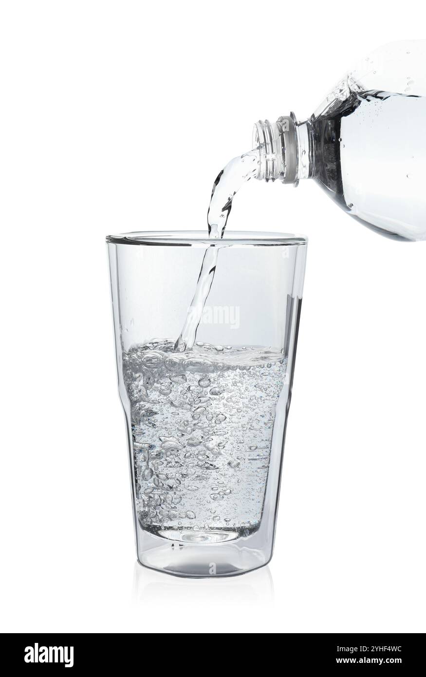 Pouring soda water from bottle into glass on white background Stock ...