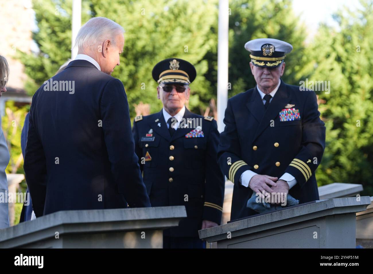 President Joe Biden looks at a memorial plaque during the plaque ...
