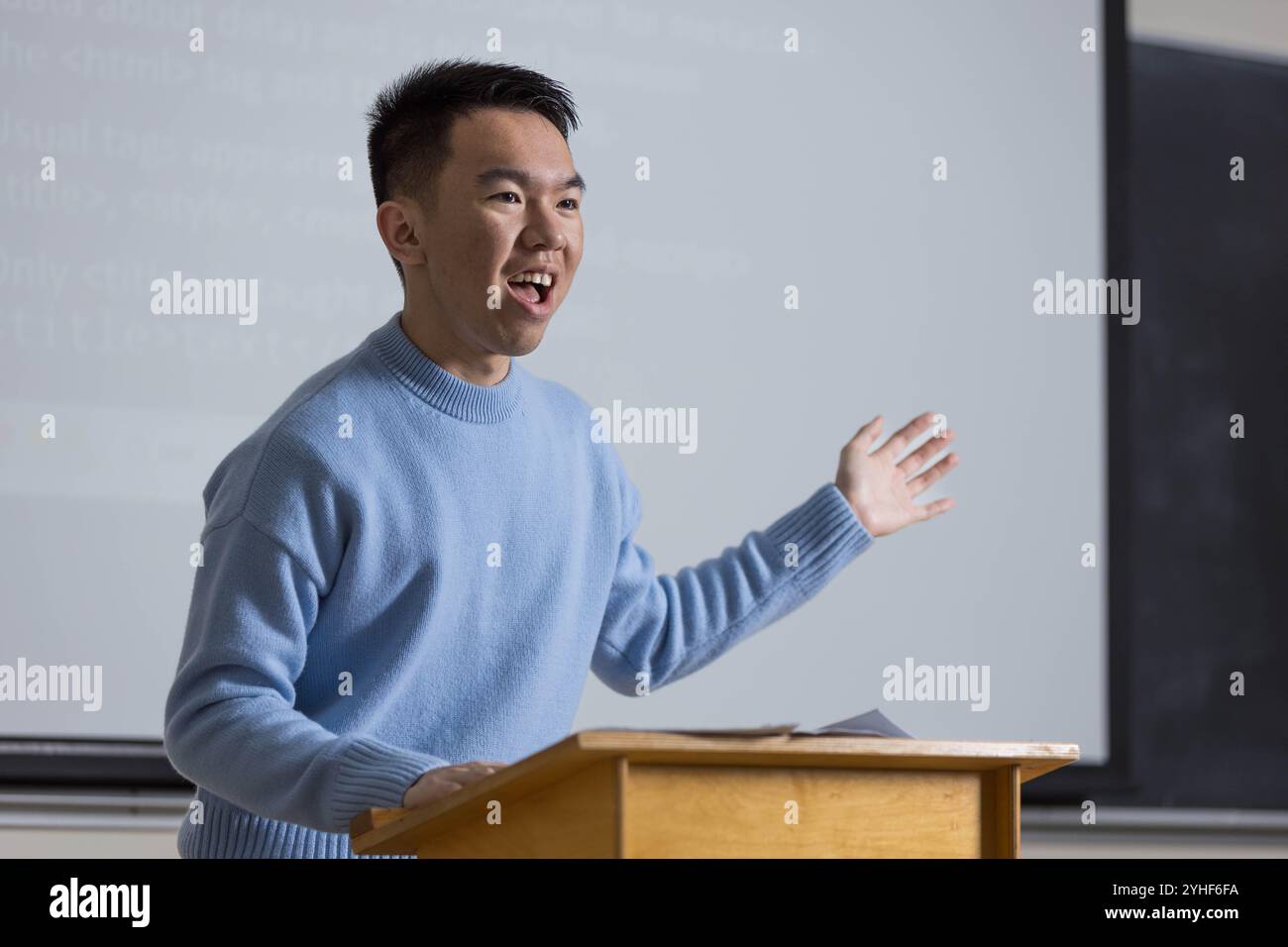 A young university student giving a confident presentation speech in ...